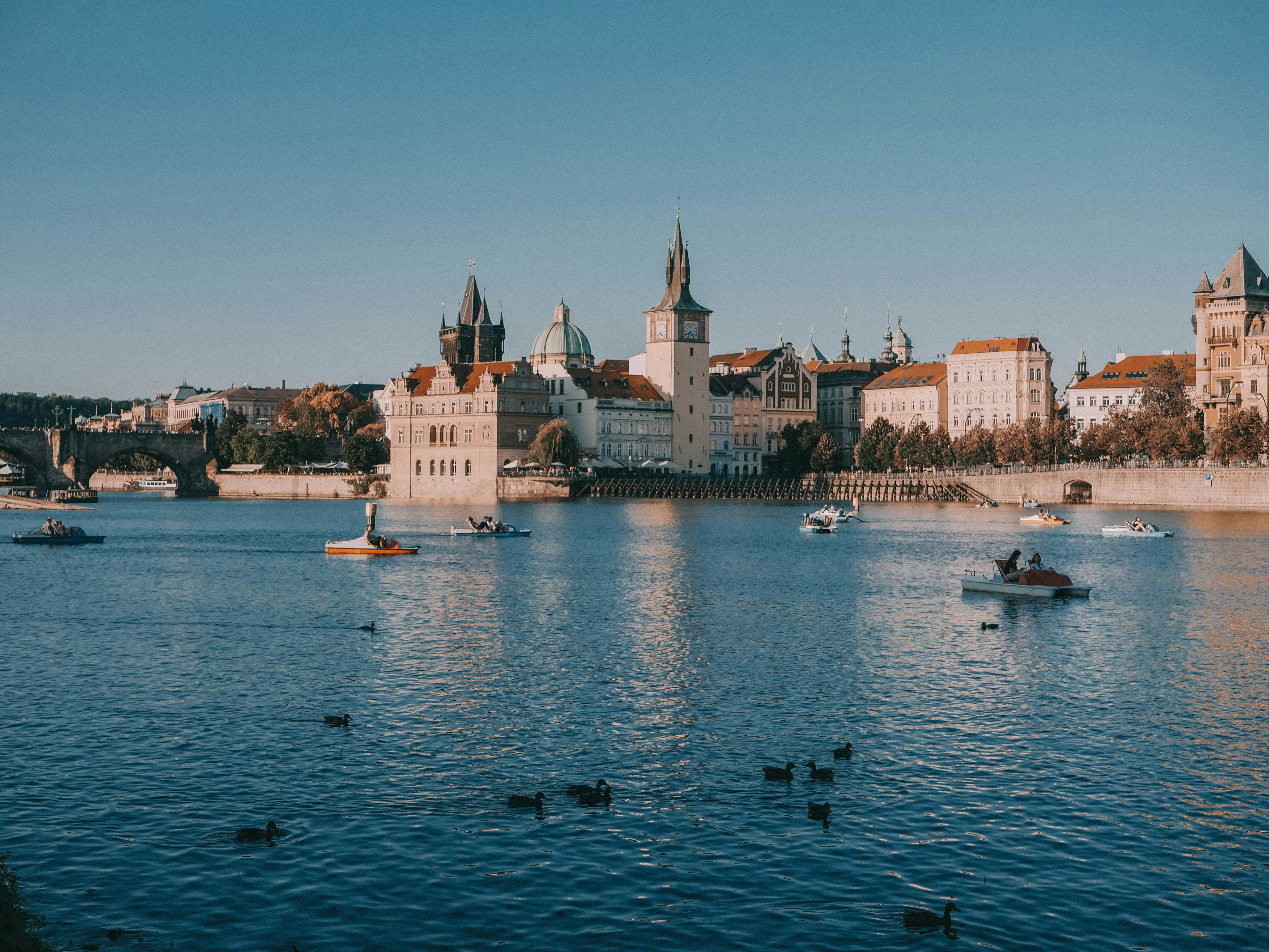 Prague’s Vltava: Towers and Boat Trails in Calm Afternoon Light