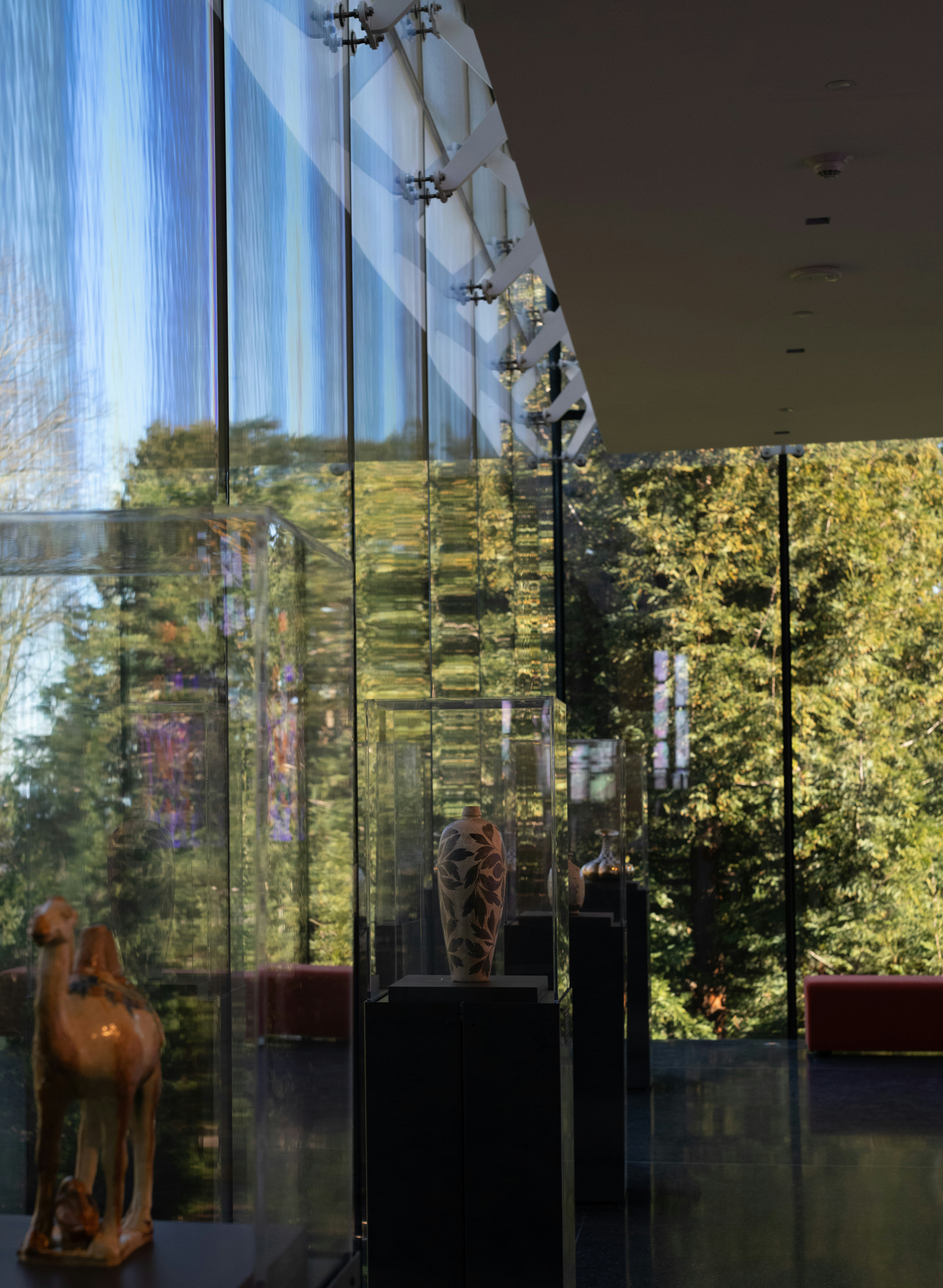 Vase on a Pedestal: Light, Reflections, and a Garden View