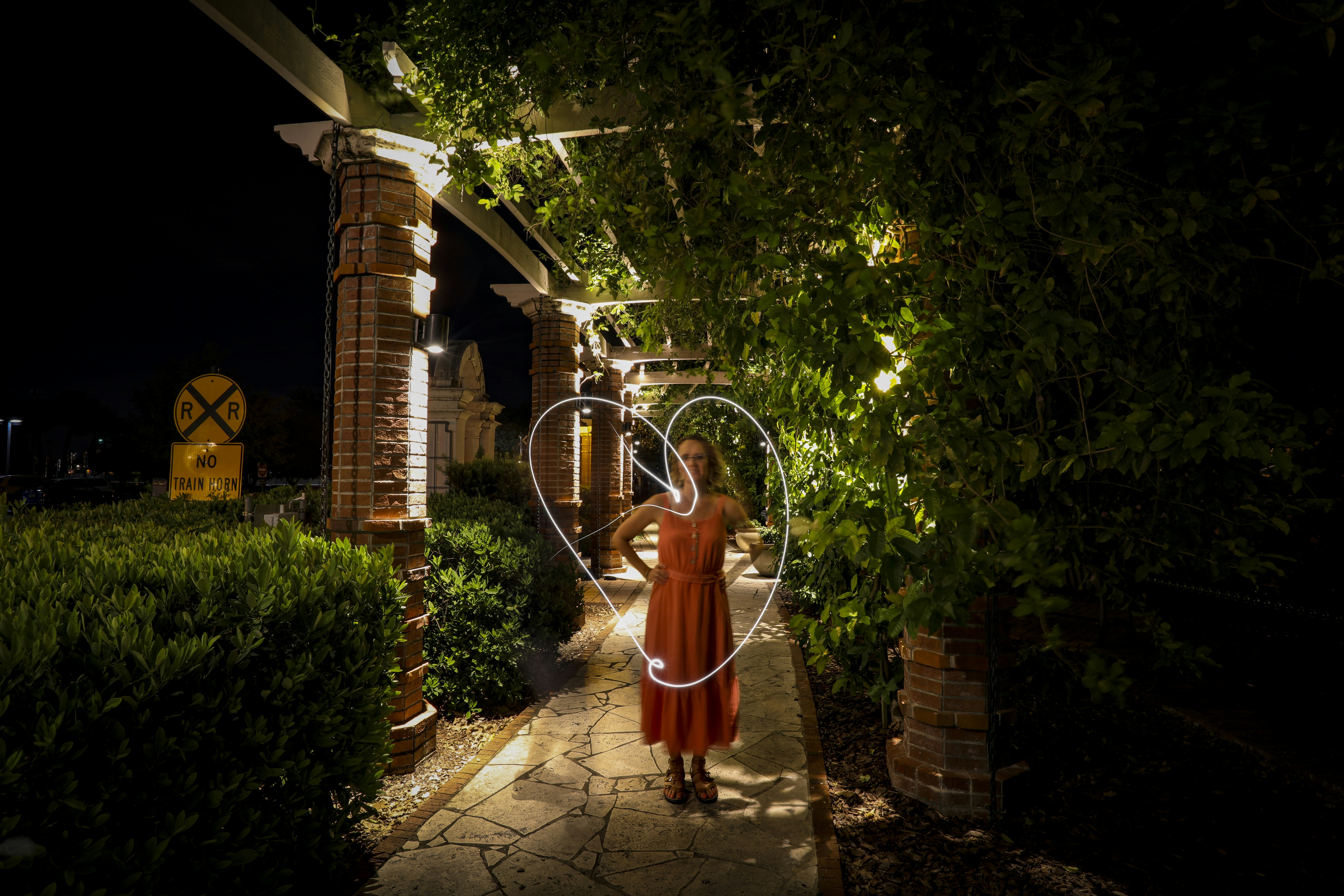 Moonlit Veranda Dance: A Figure in Ember Red