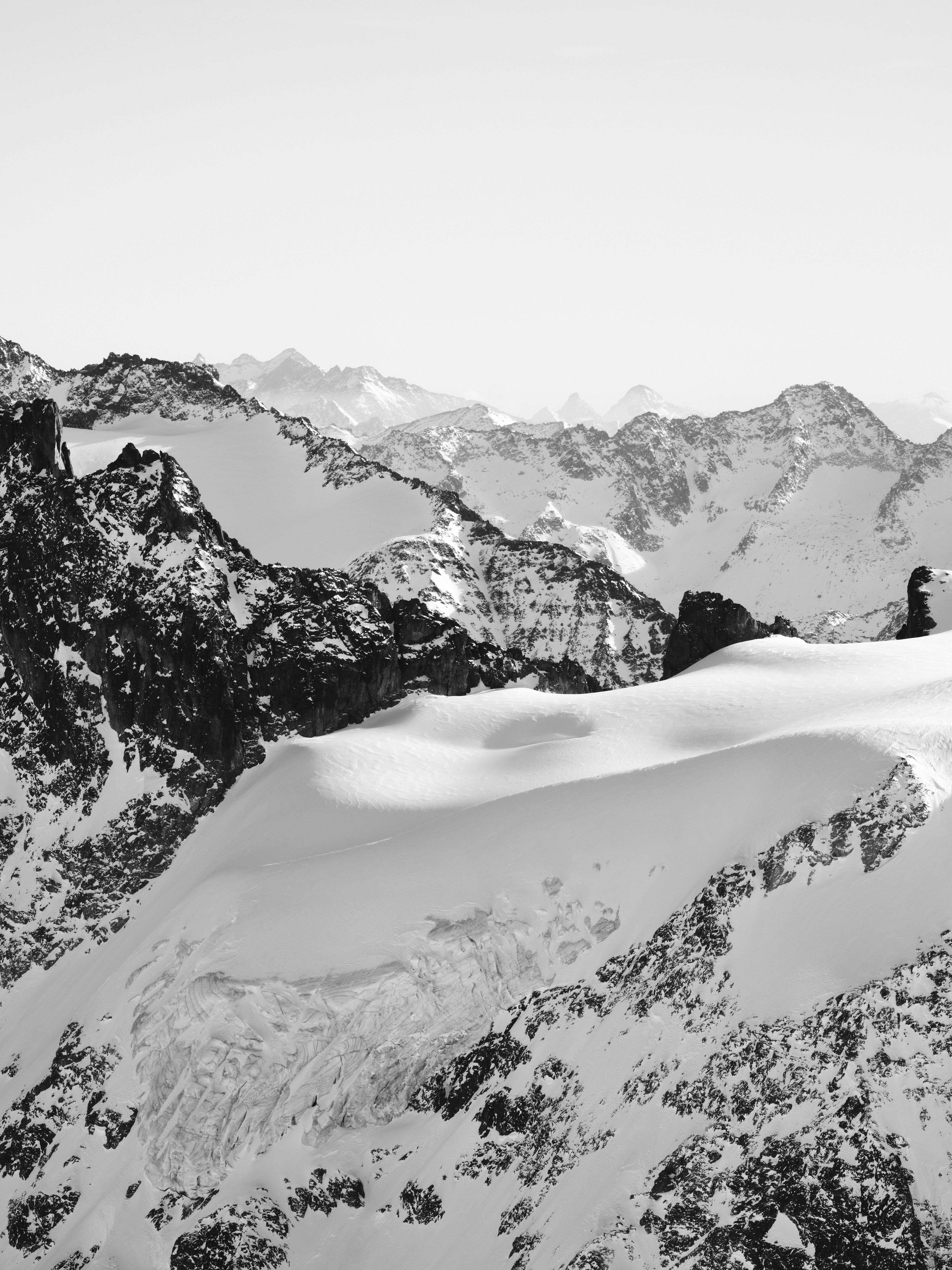 Snowbound Spine: A Chiseled Ridge Reaches Toward a Pale Sky
