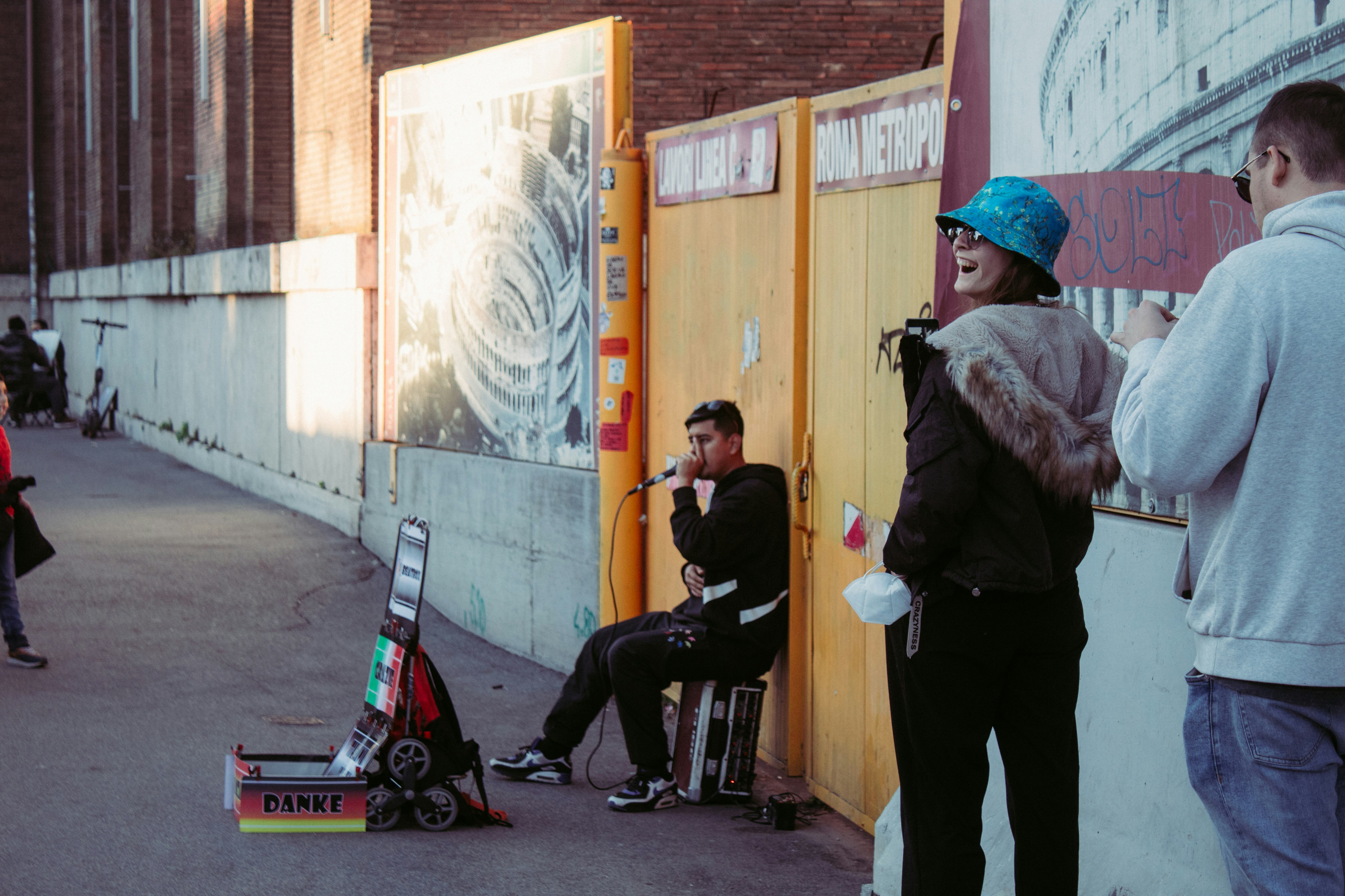 a group of people standing next to a wall
