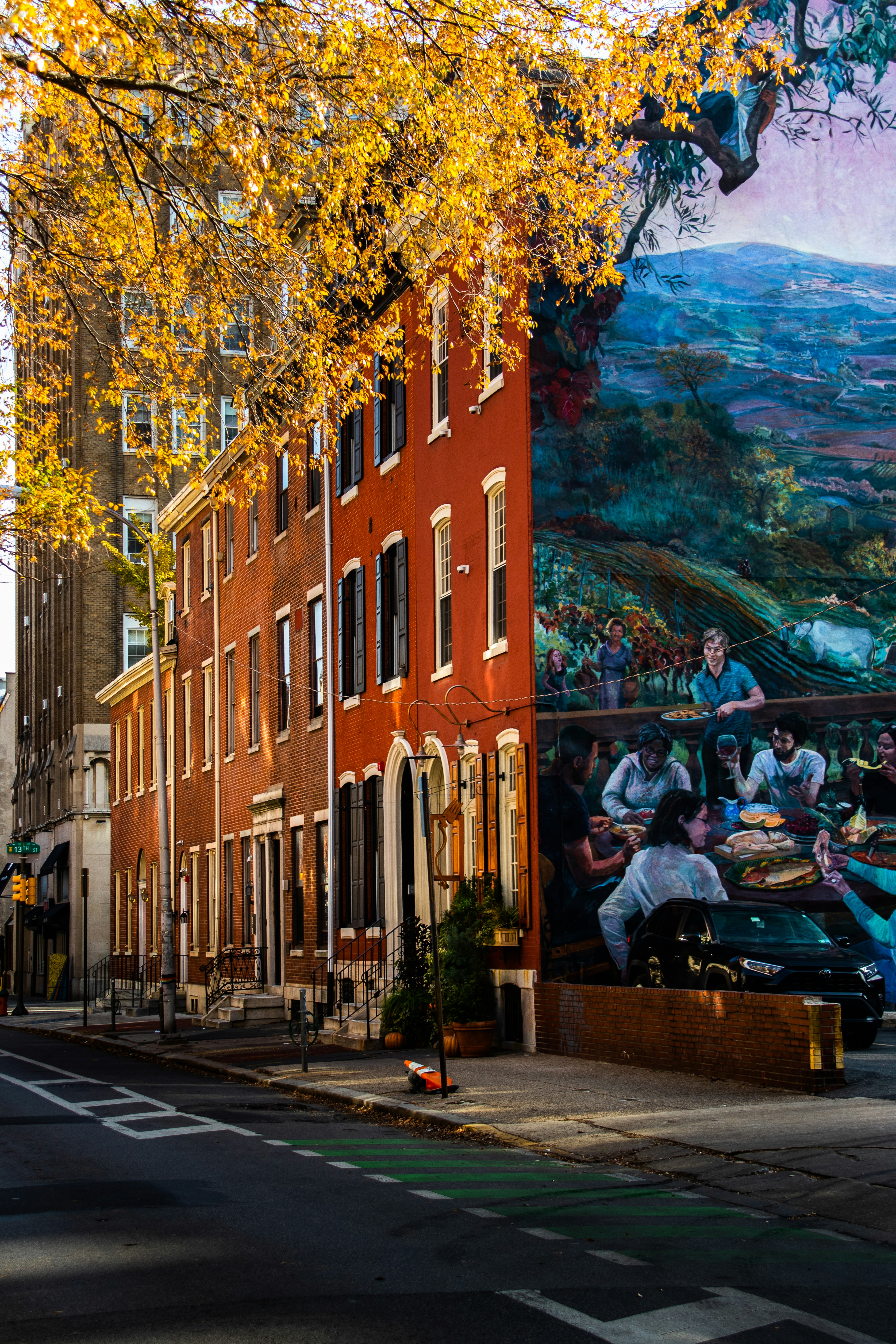 Colorful Mural Meets Quiet Street: A City Block Between Brick Facades
