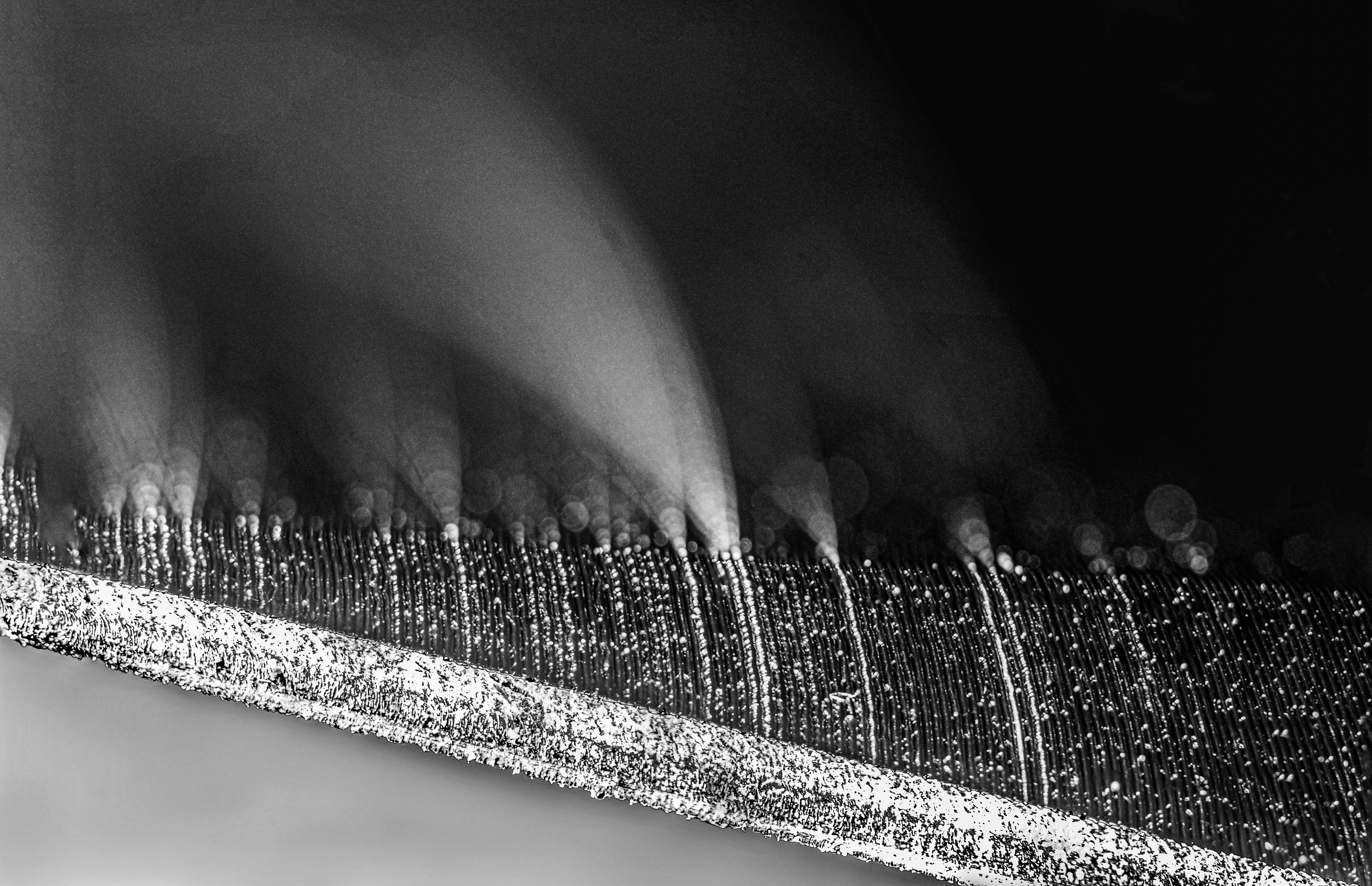 A black and white photo of water spewing from a pipe photo – Free ...