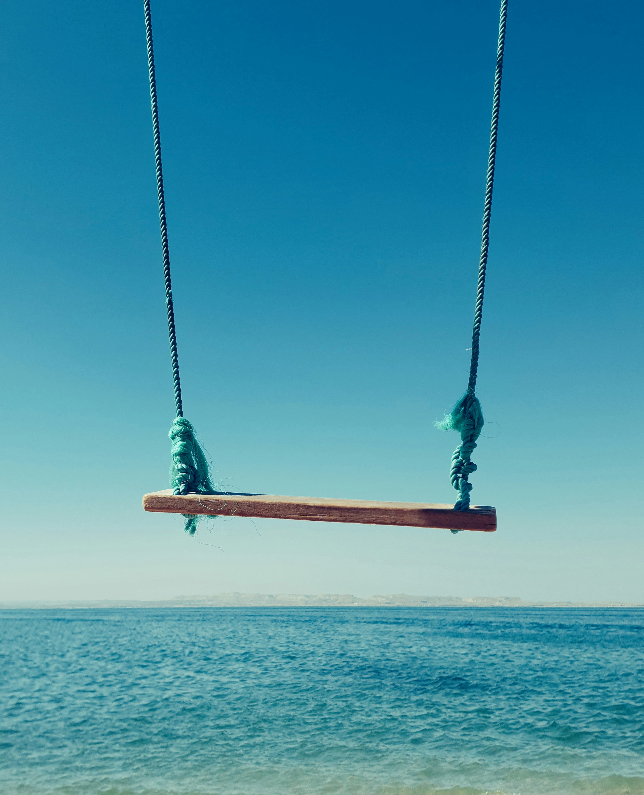 Horizon Swing: A Quiet Moment Above the Blue Expanse
