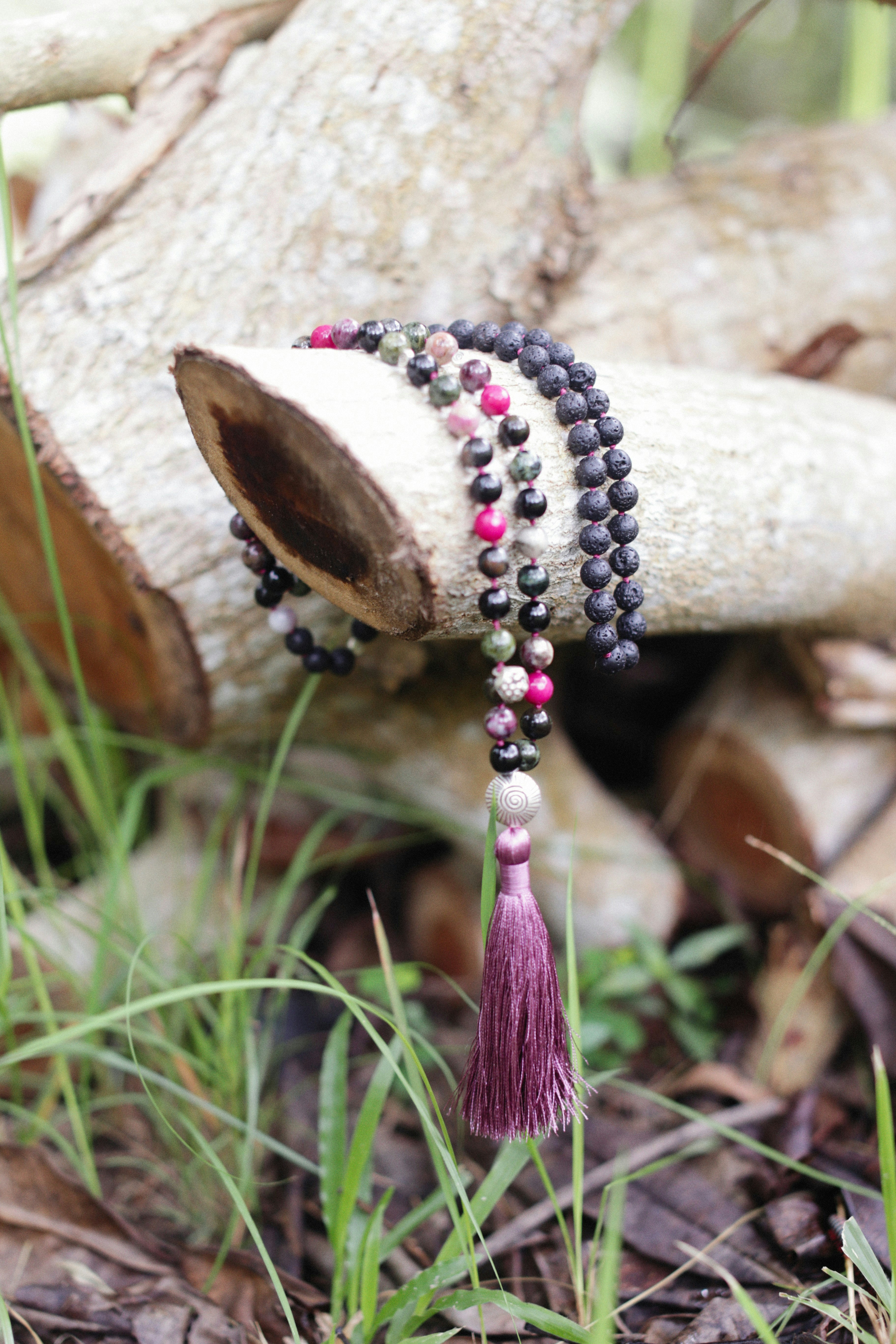 a long beaded necklace with a tassel hanging from it