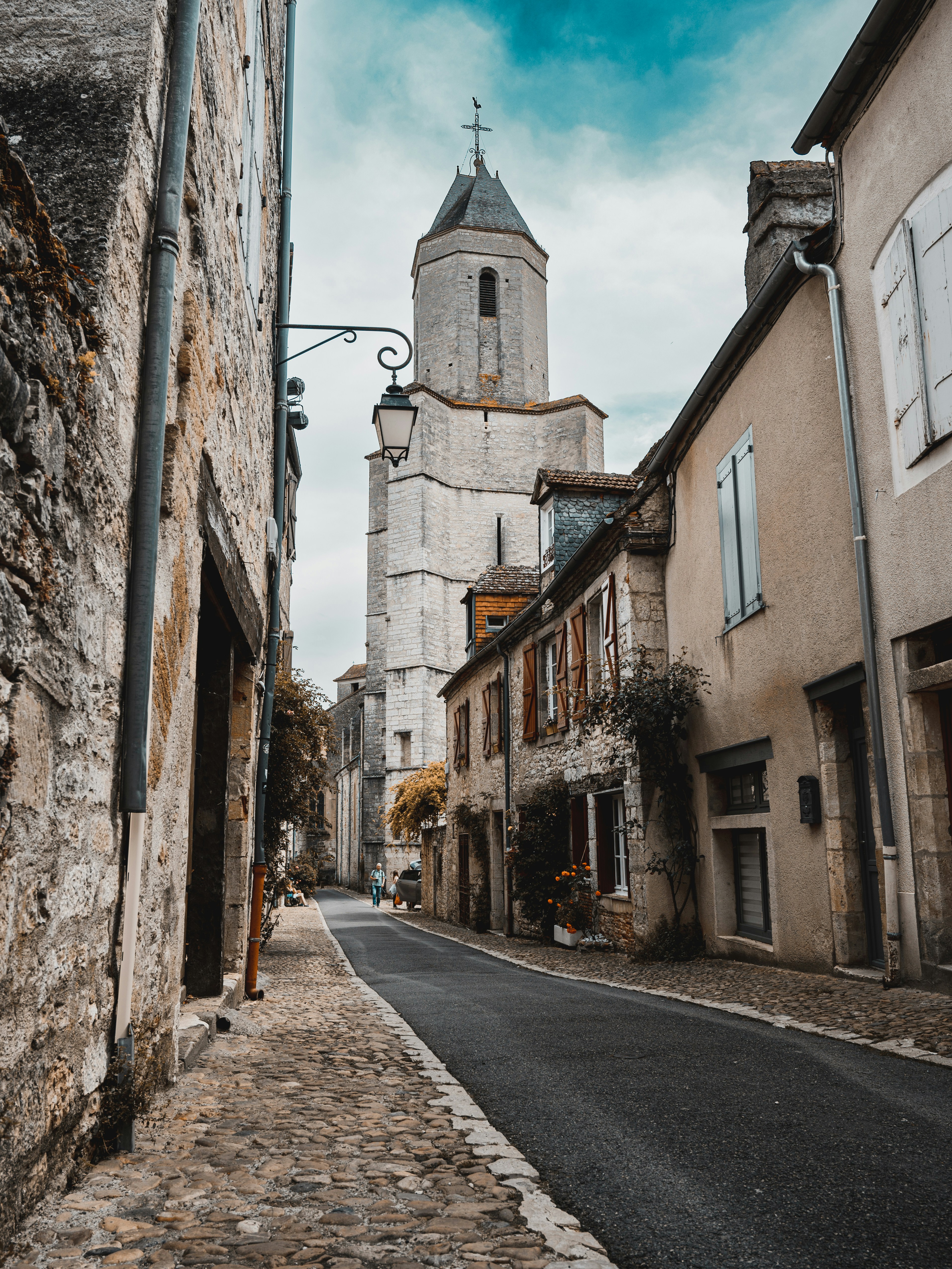 Towered Alleyway: A Narrow Street Framing a Medieval Bell Tower