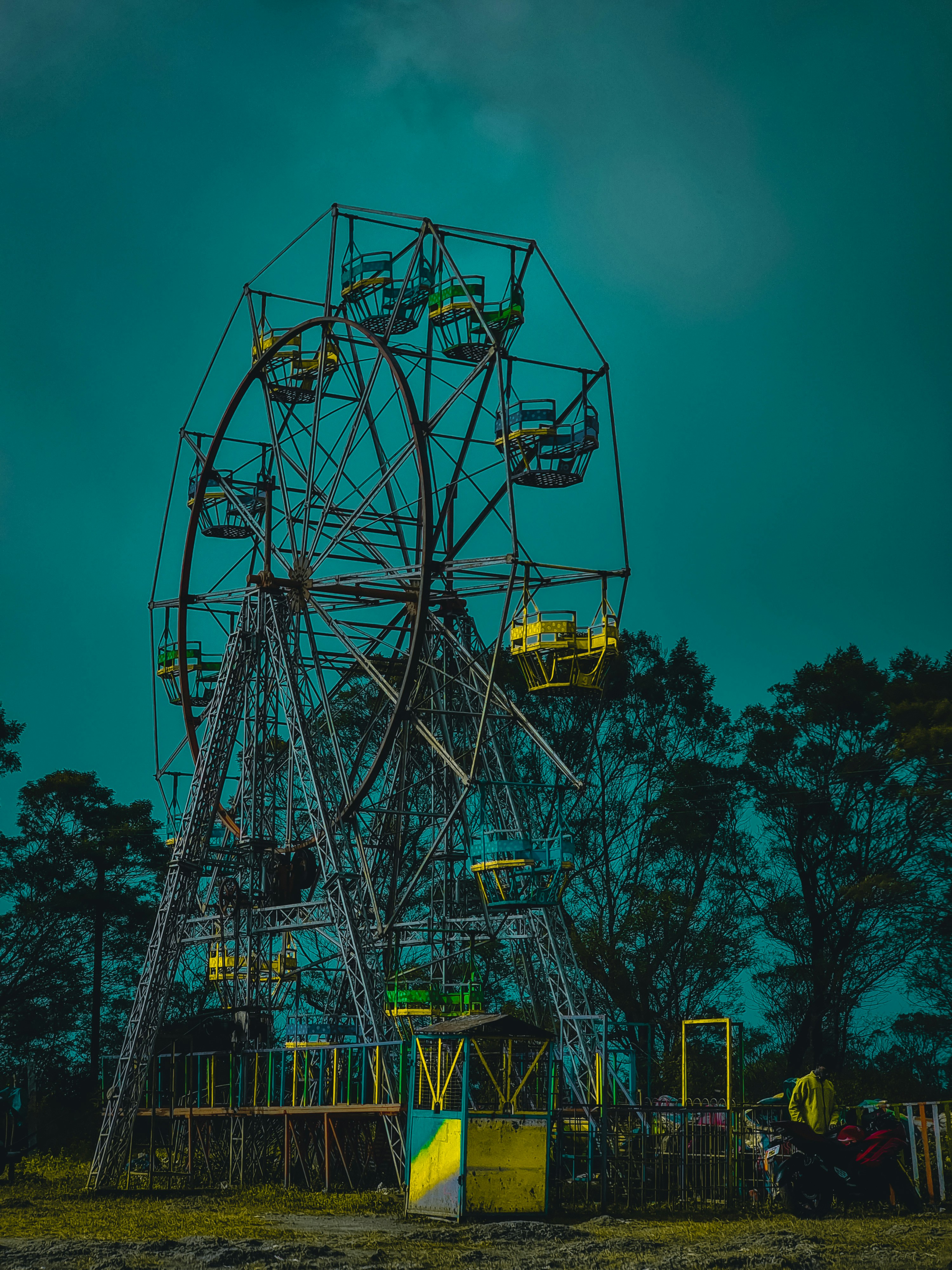 Teal Dusk Ferris Wheel Over a Quiet Pine Horizon