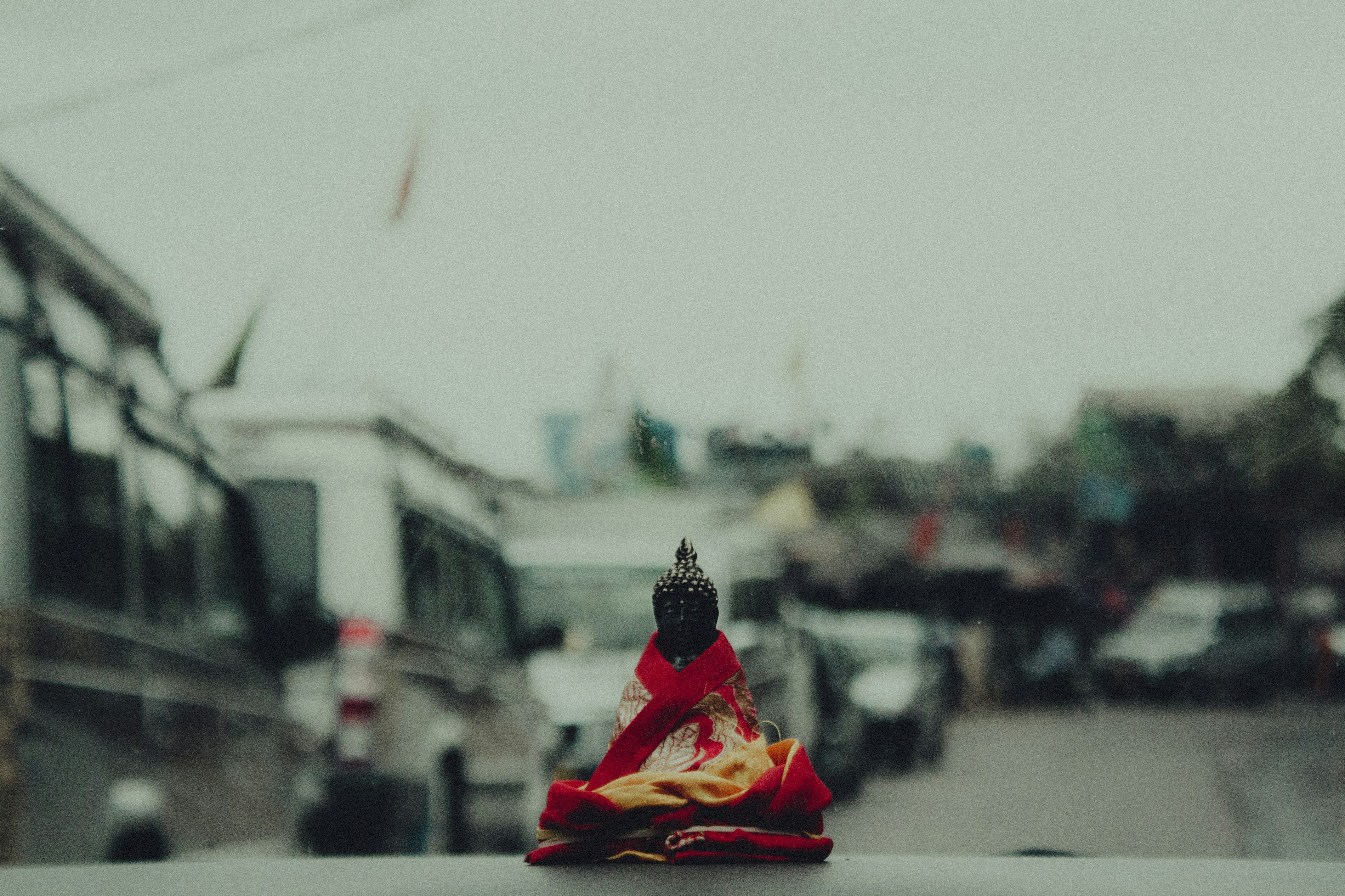 a statue of a person in a red and yellow outfit