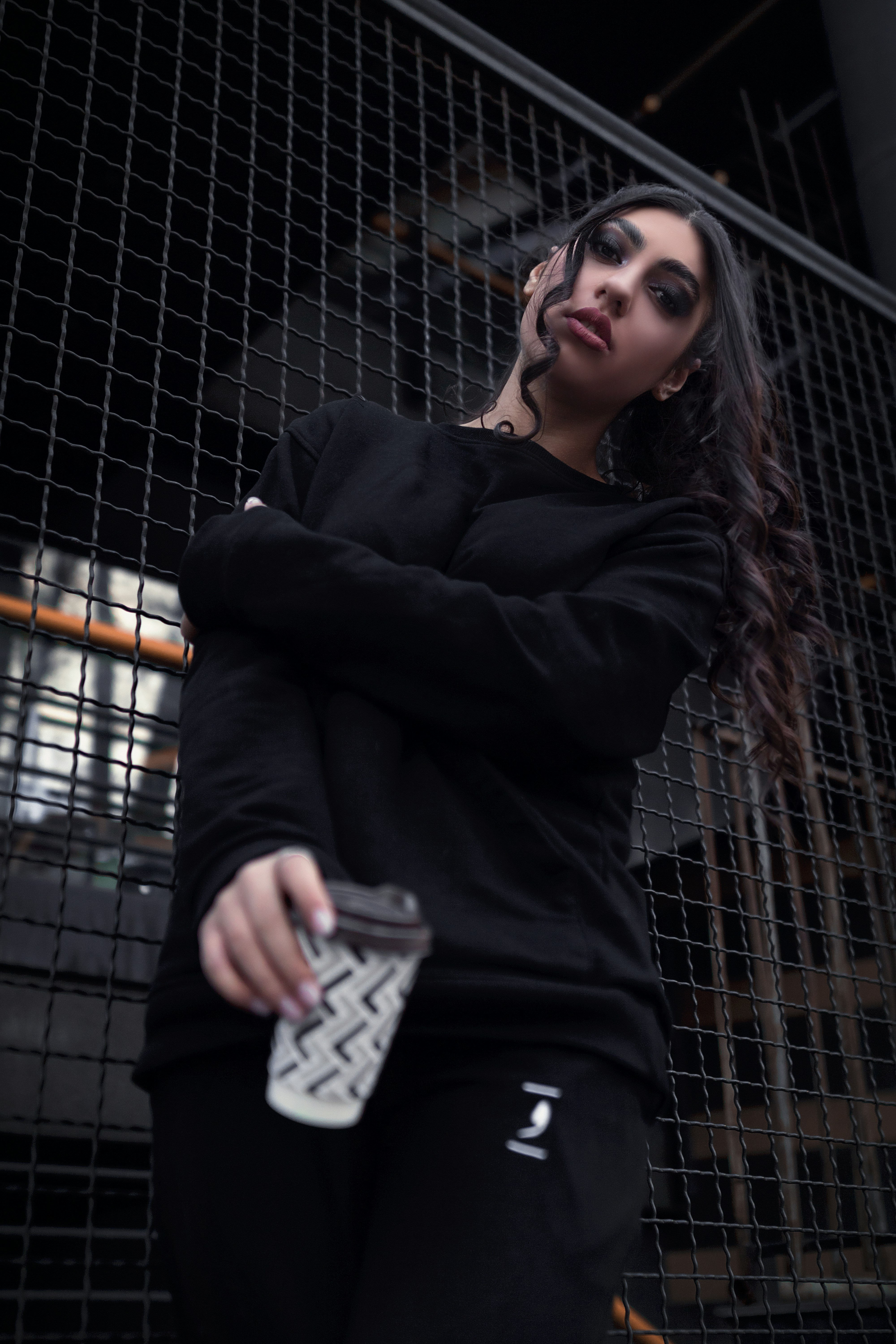 Urban Nightstride: A Confident Gaze Amid Chainlink Echoes