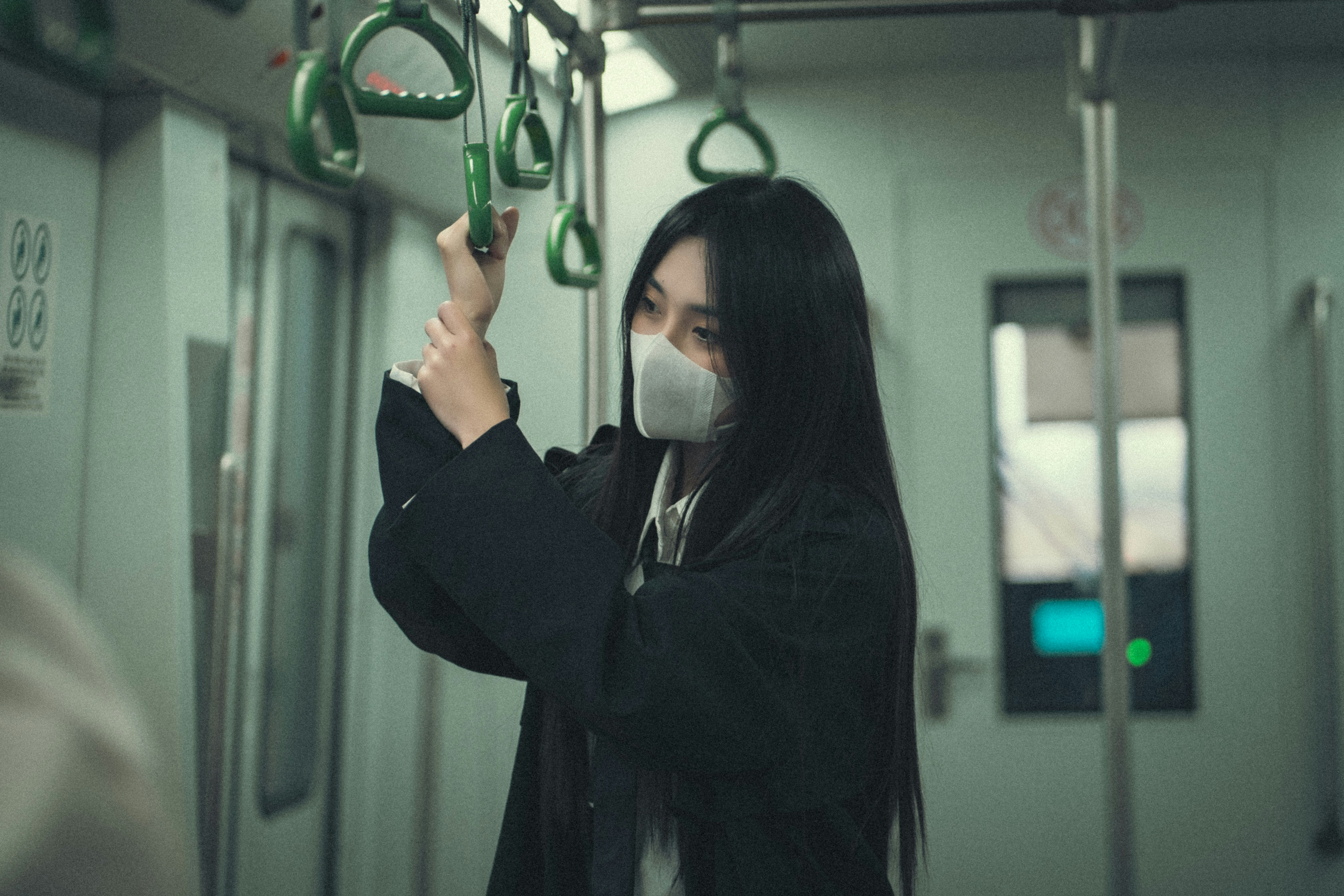 A woman wearing a face mask on a train photo – Free Station Image on ...