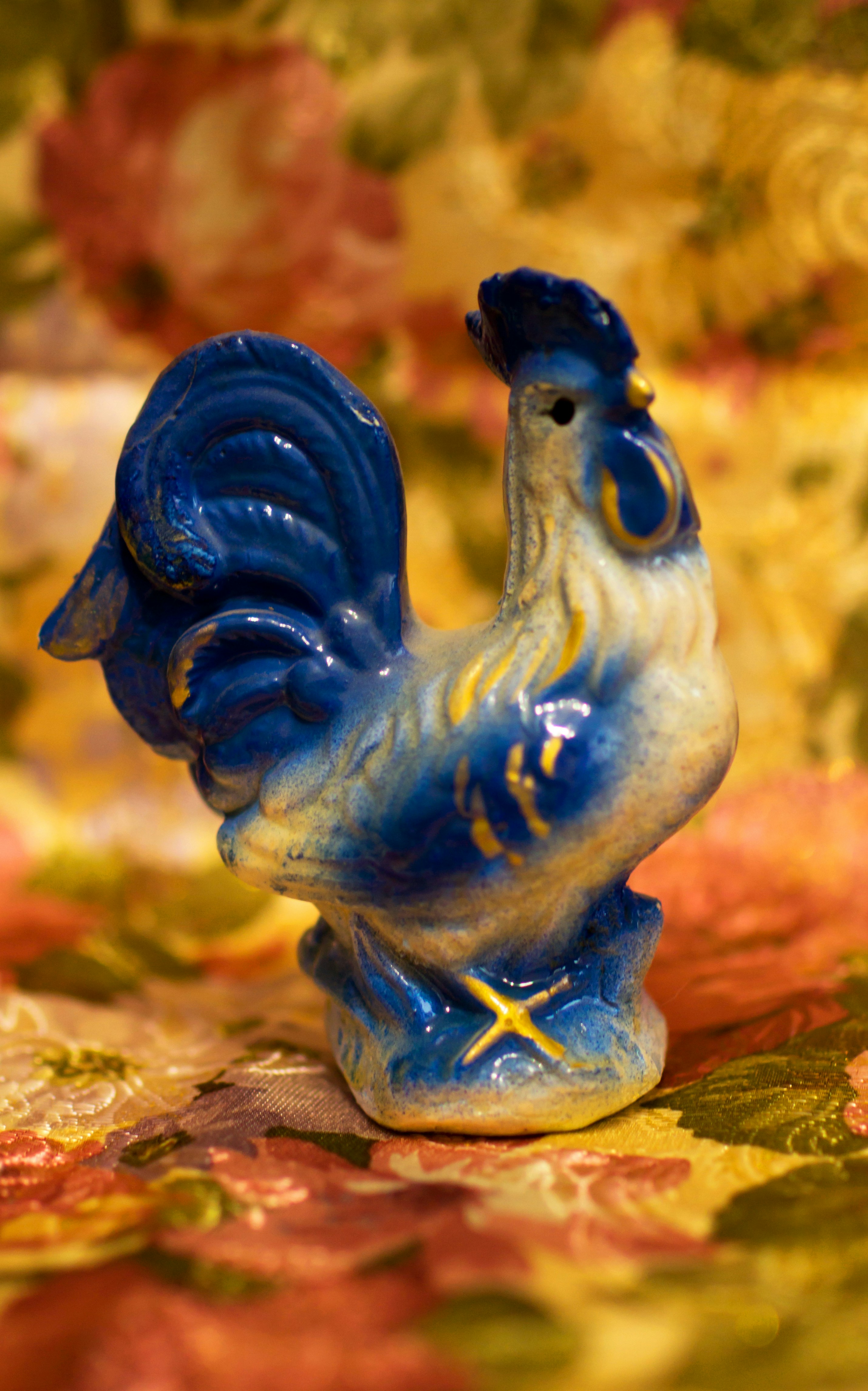 A blue ceramic rooster figurine sitting on a table photo – Free ...