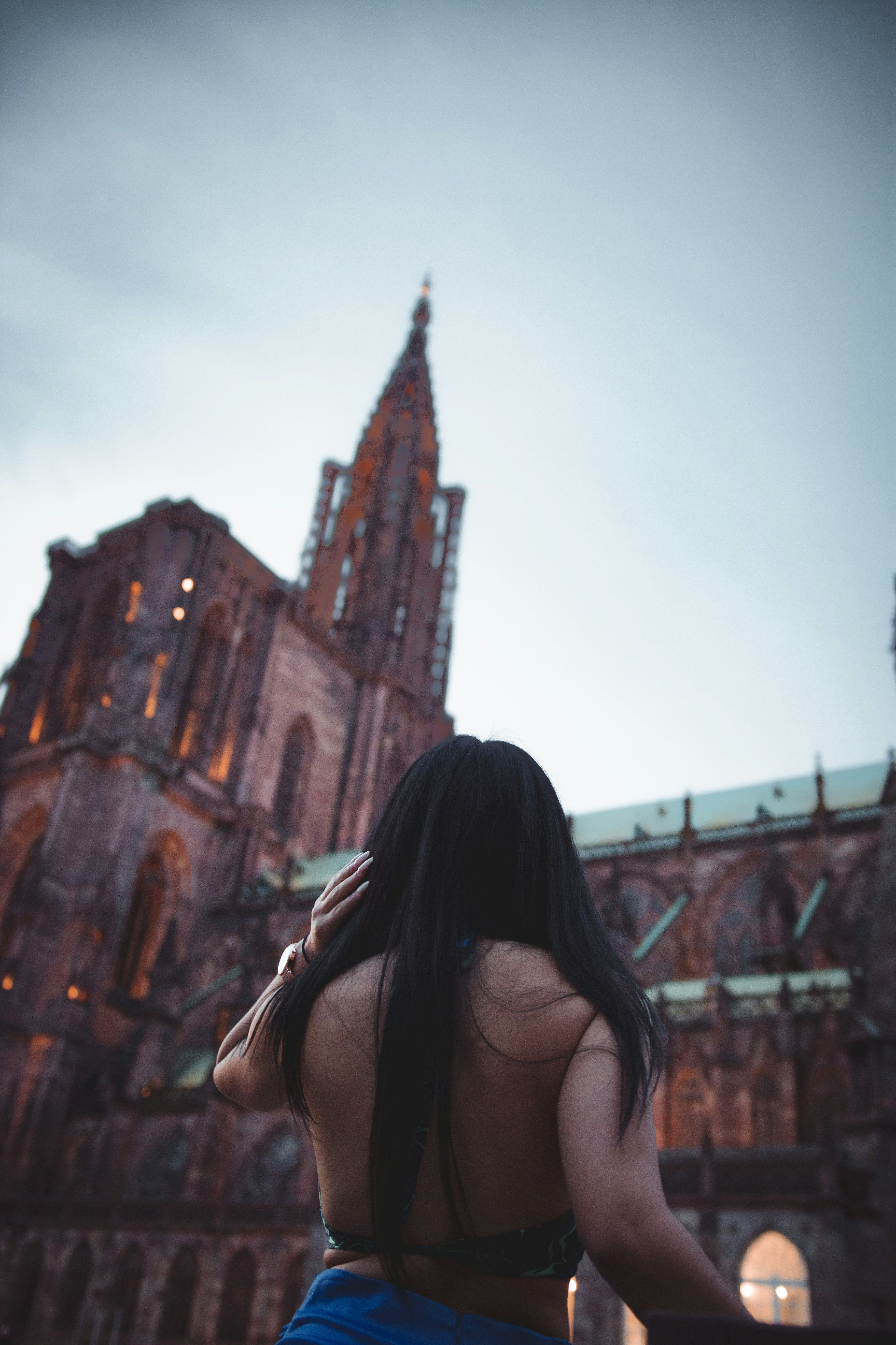 Cathedral Backdrop, Silent Gaze: A Figure in the Foreground