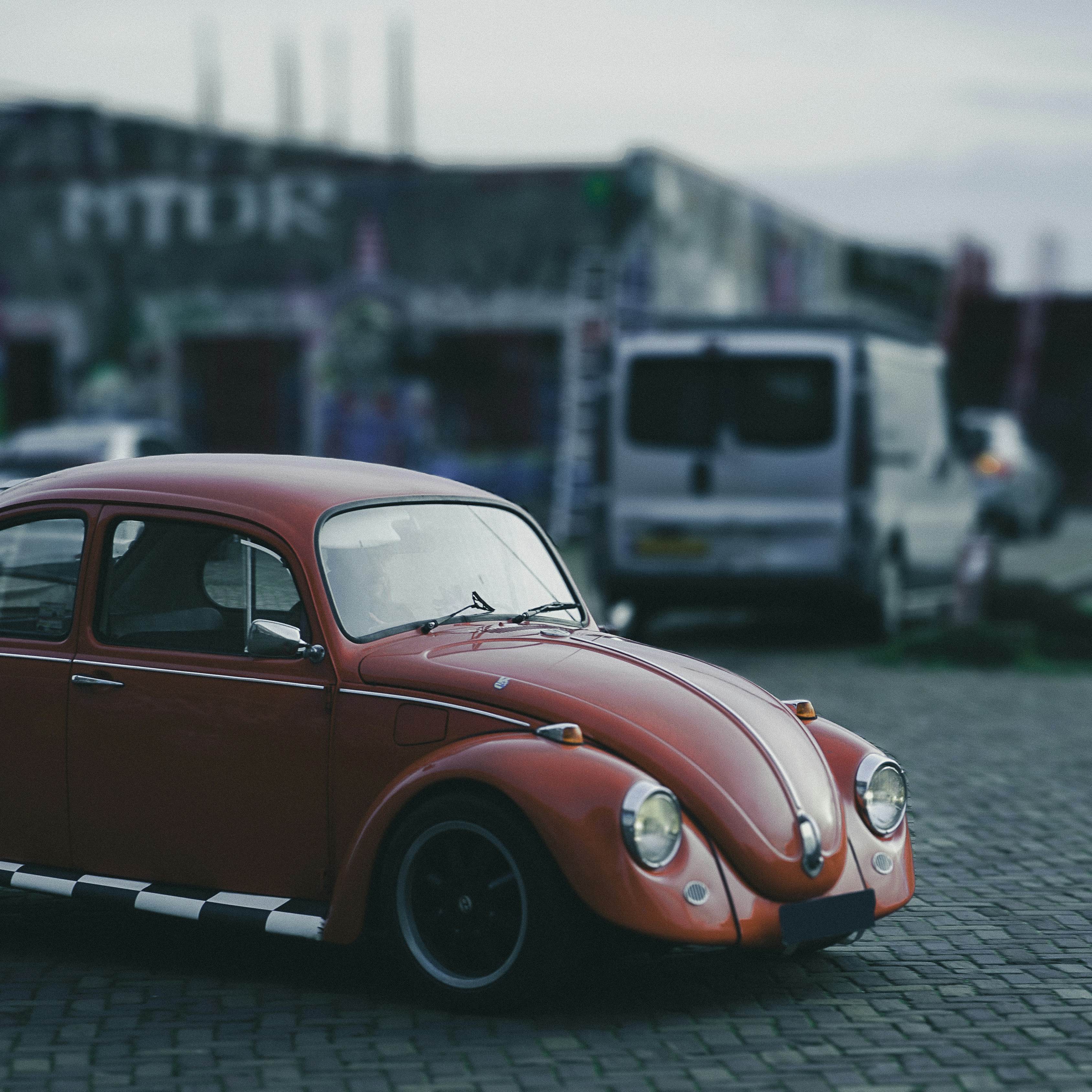 Red VW Beetle on Cobblestones: A Quiet Urban Moment