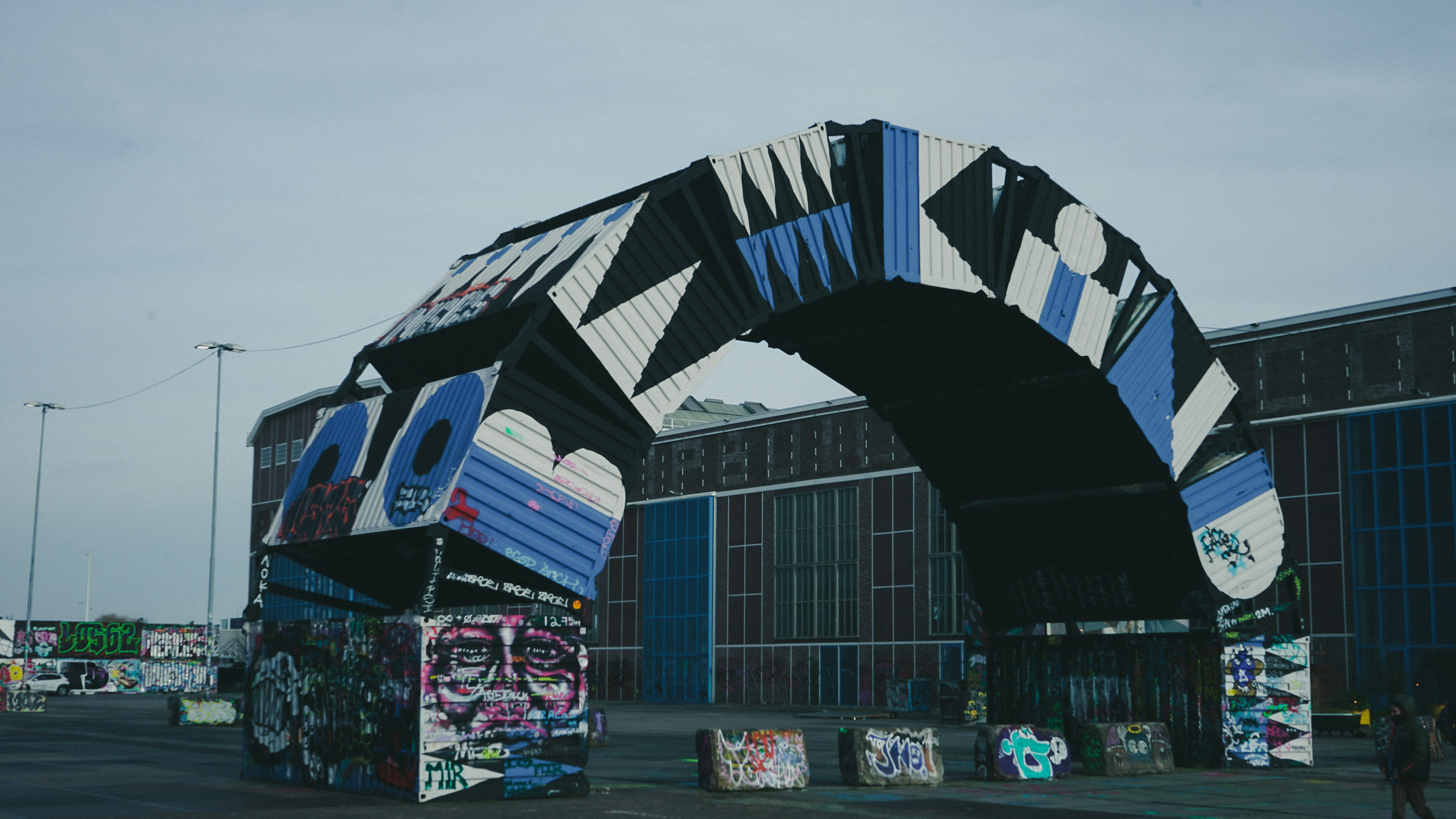 Color-Block Arch: Graffiti-Stamped Container Gateway in an Industrial Yard