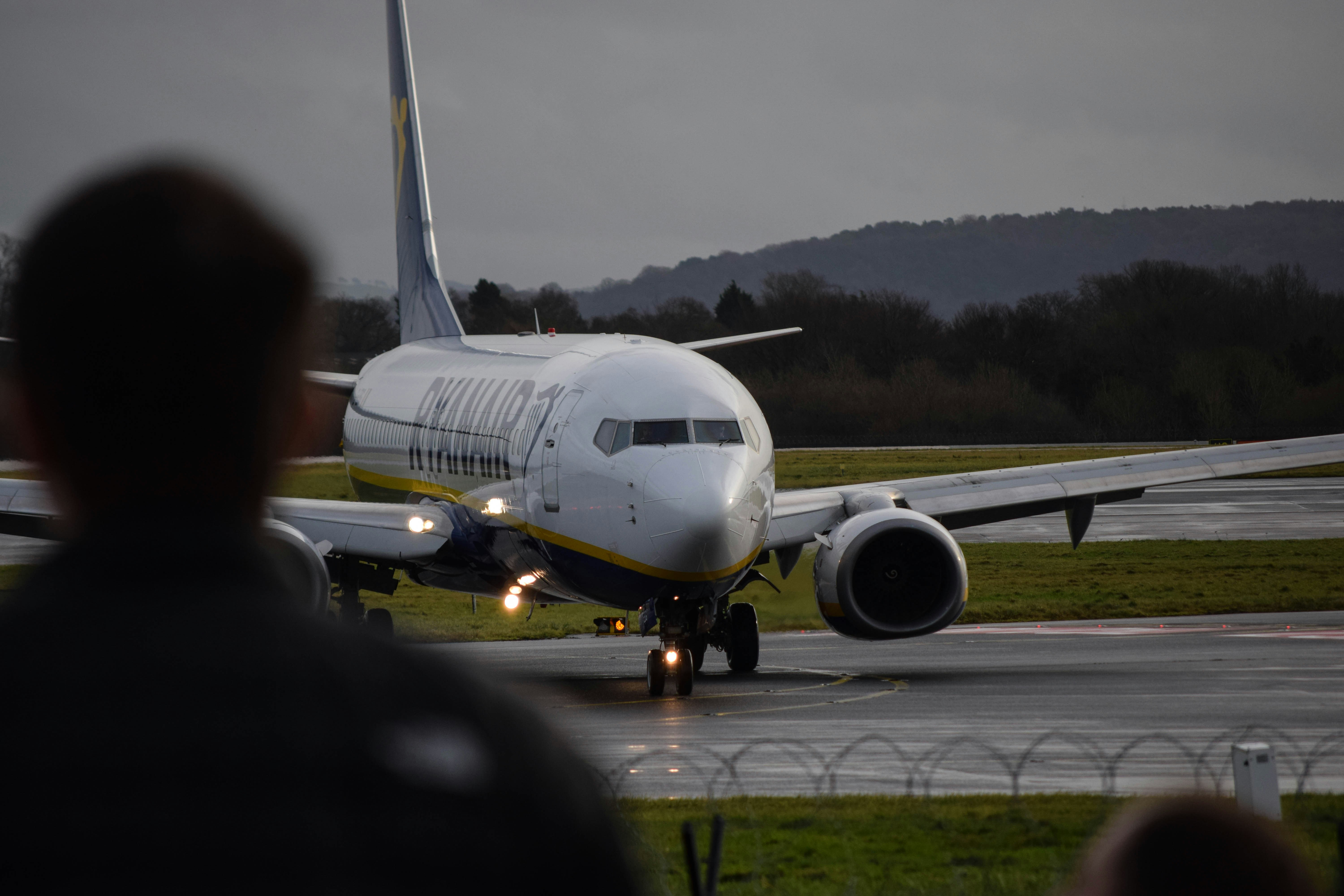 A large passenger jet sitting on top of an airport runway photo – Free ...