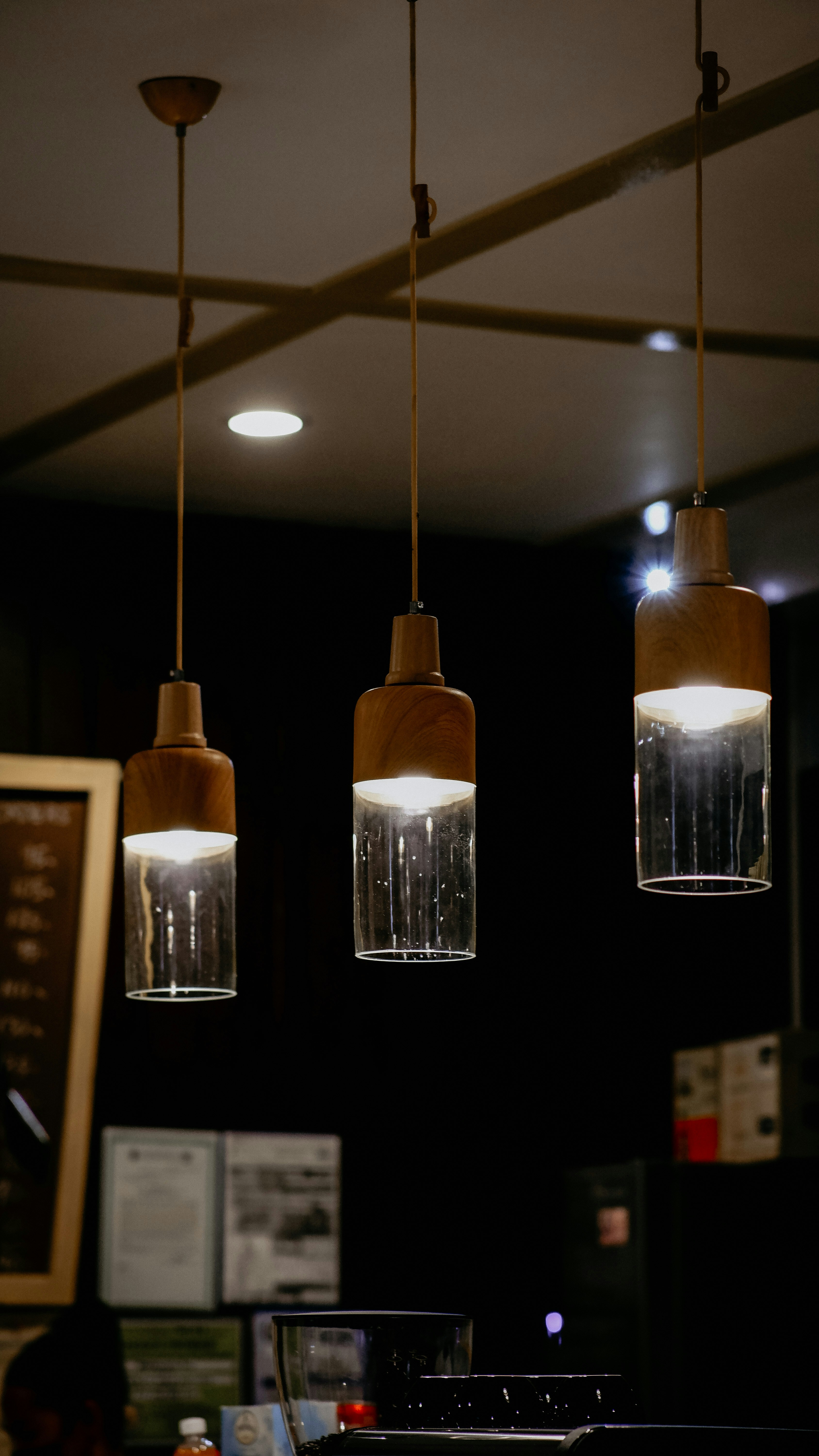 Warm Glow: Trio of Industrial Pendants in a Dim Café