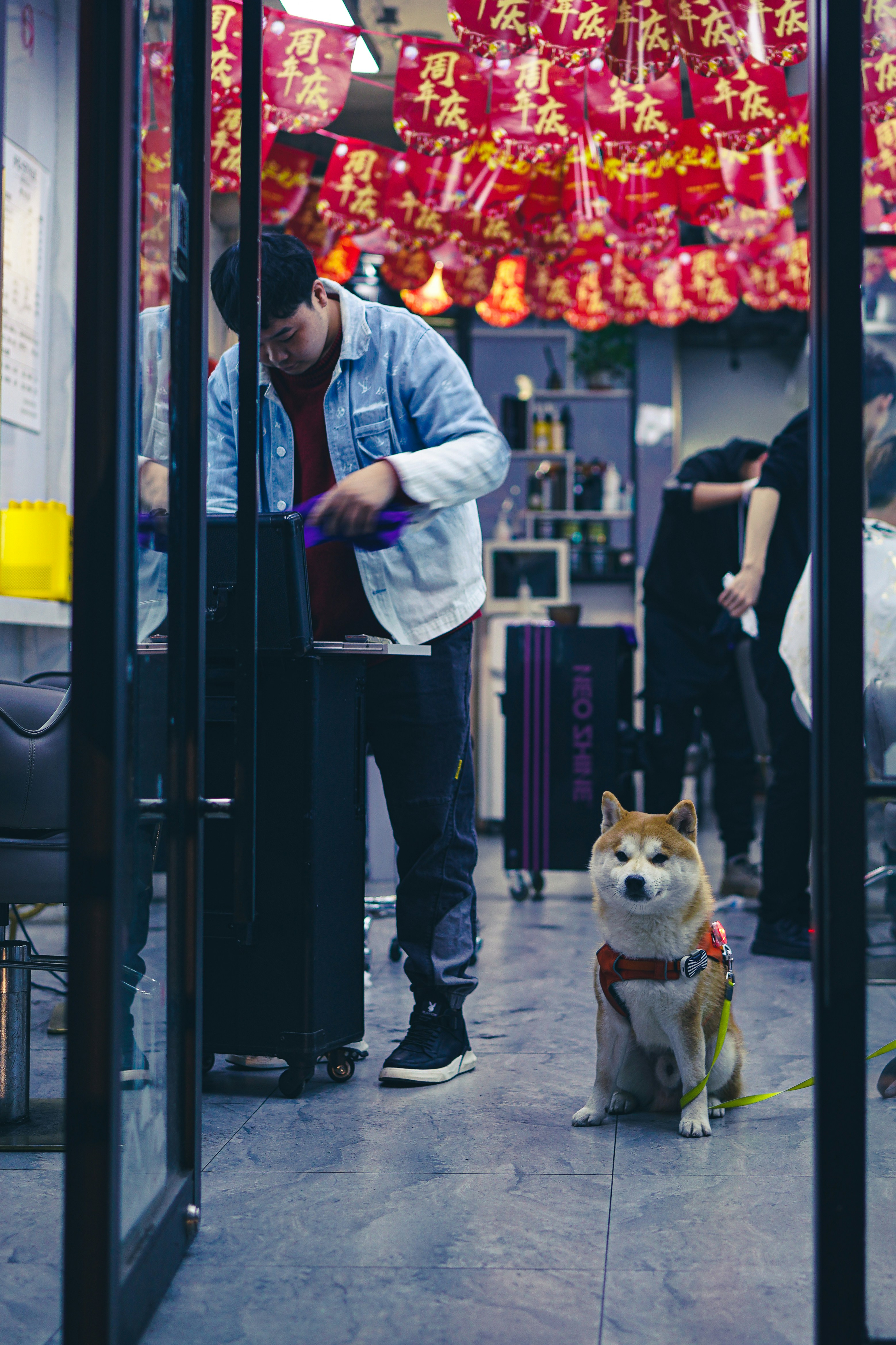 a man standing next to a dog inside of a store