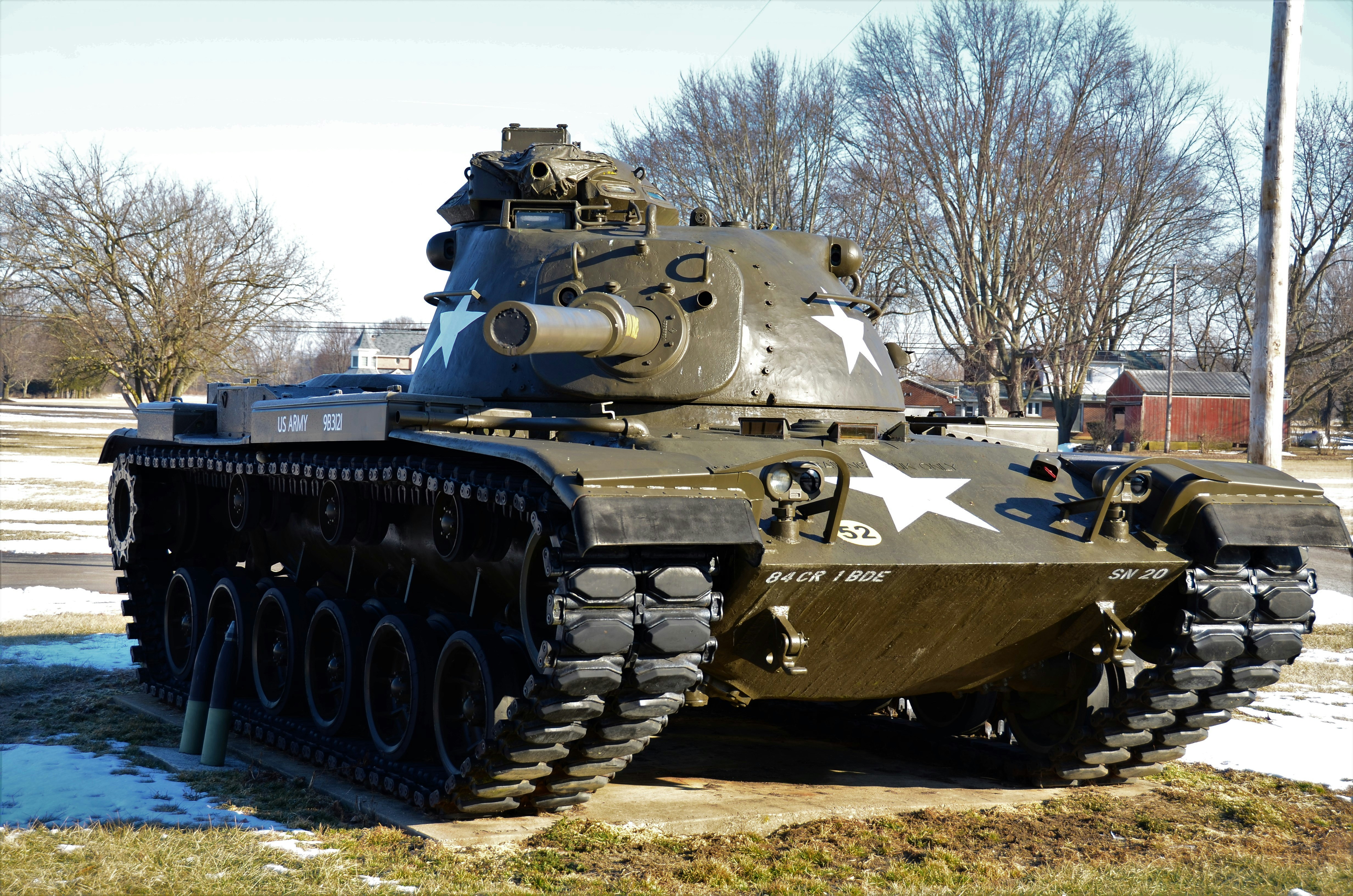 A military tank sitting on top of a grass covered field photo – Free ...