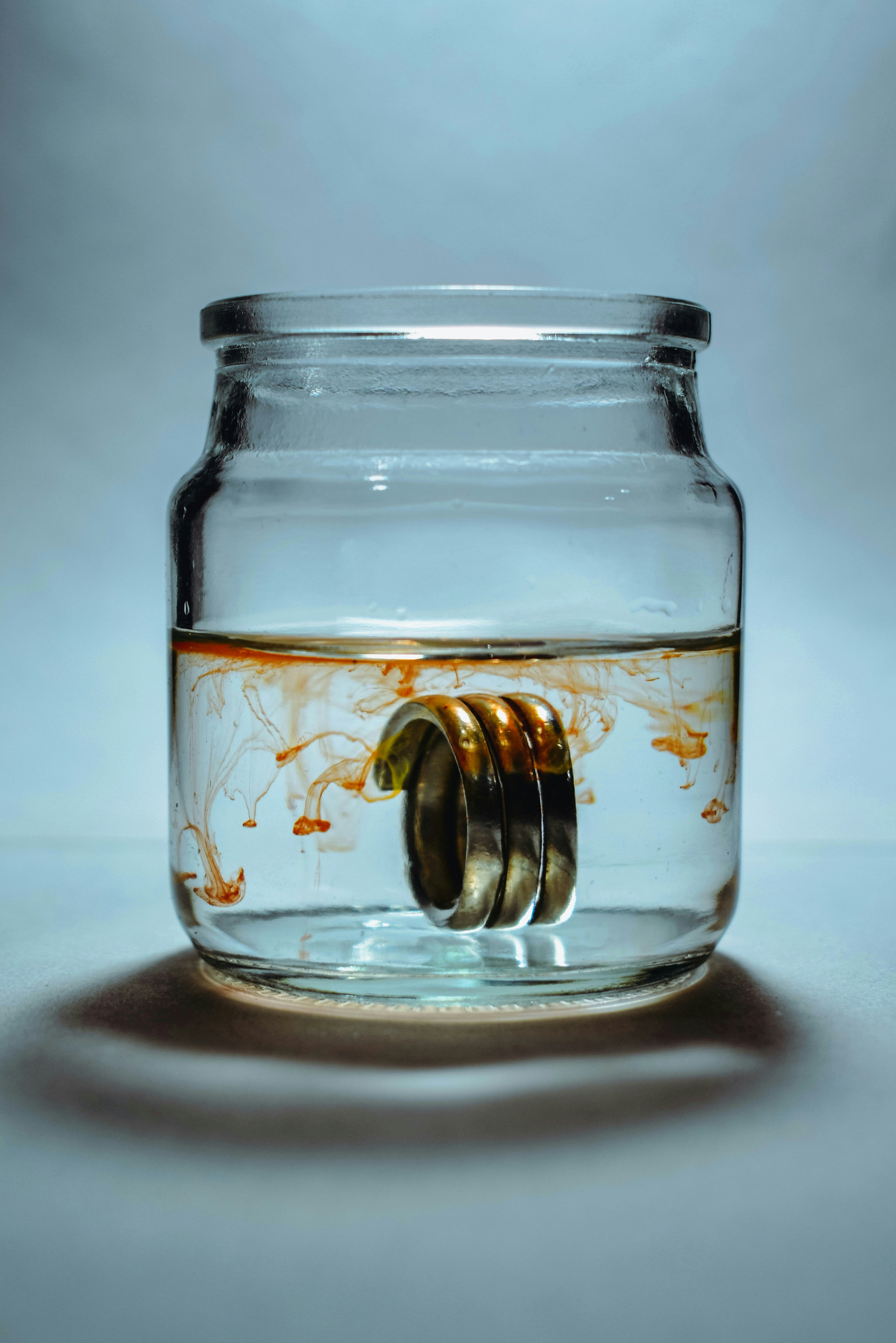 A glass jar filled with liquid and gold rings photo – Free Glass jar ...
