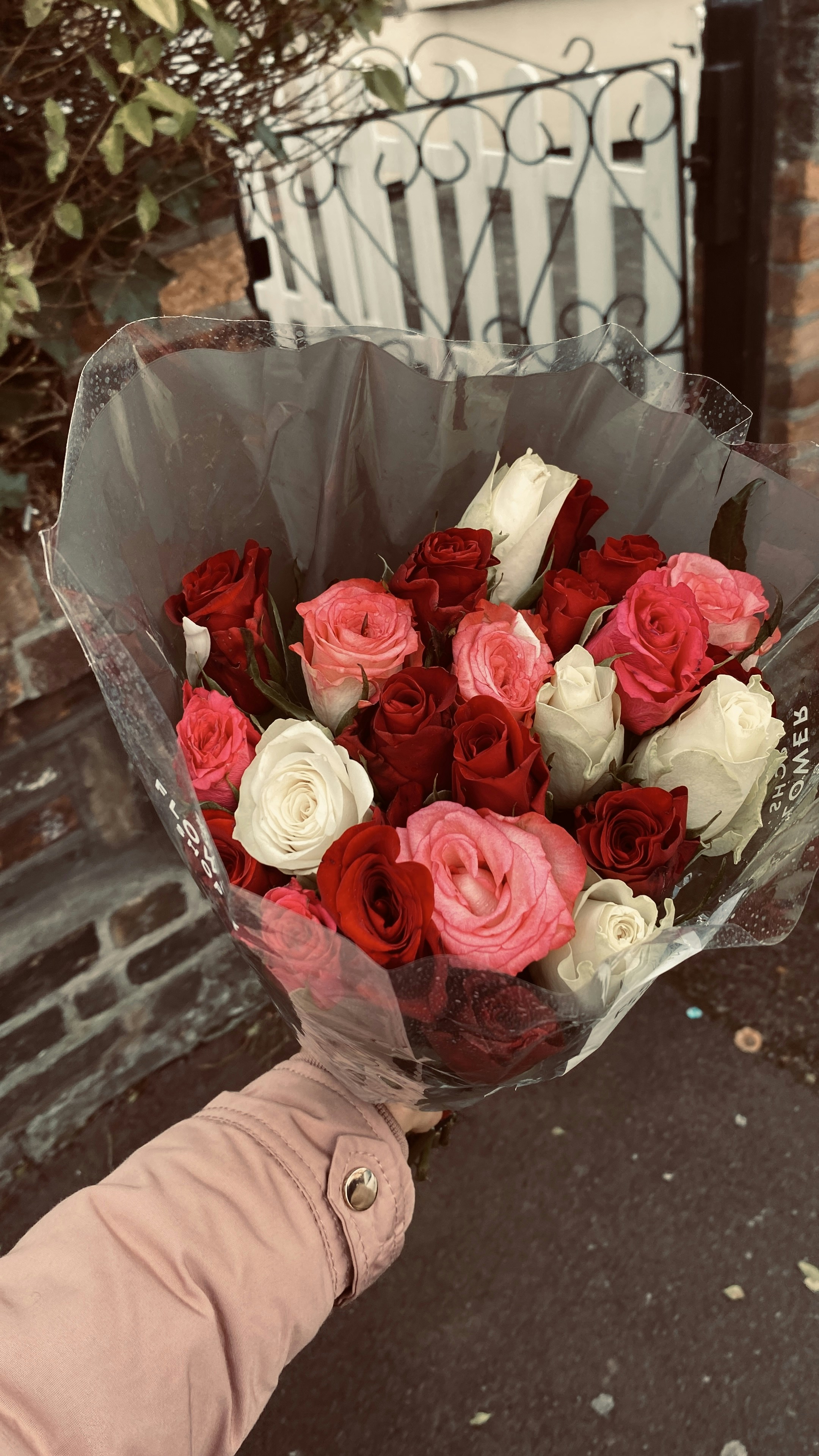 a person holding a bouquet of roses in their hand