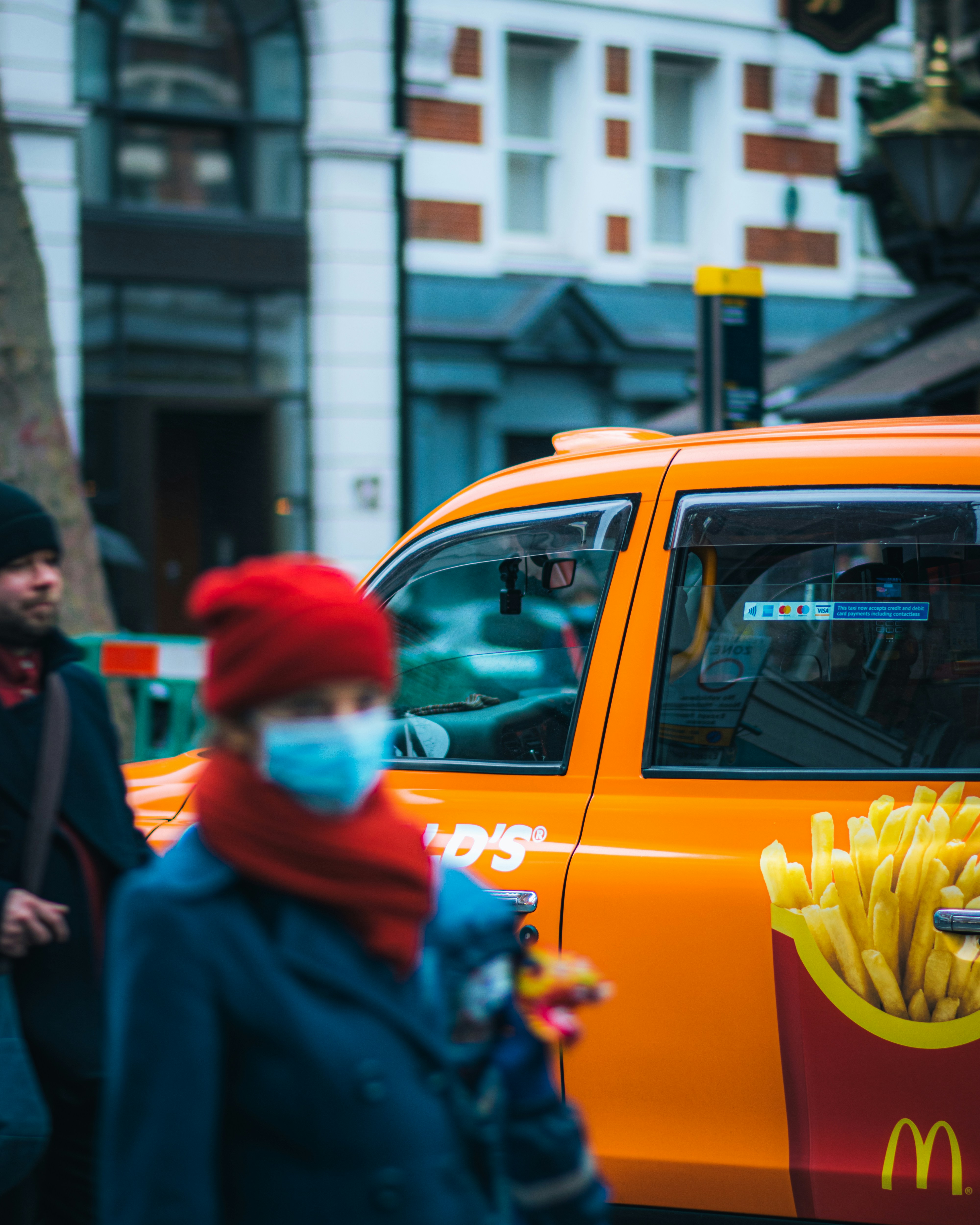 Orange Taxi, Red Scarf, and a City Street Morning
