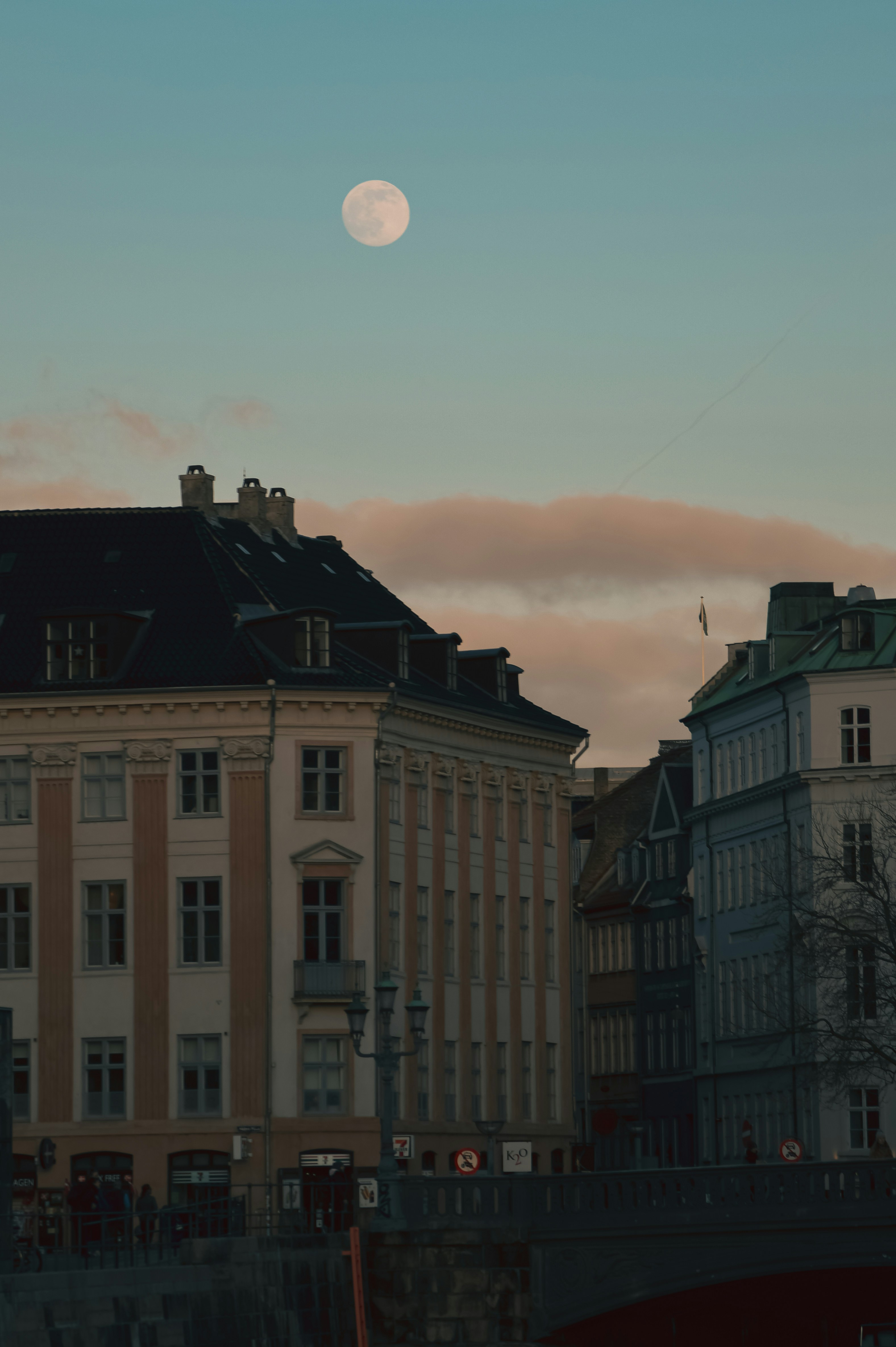 Moon Above the Canal-Facades: Twilight in a Historic Quarter