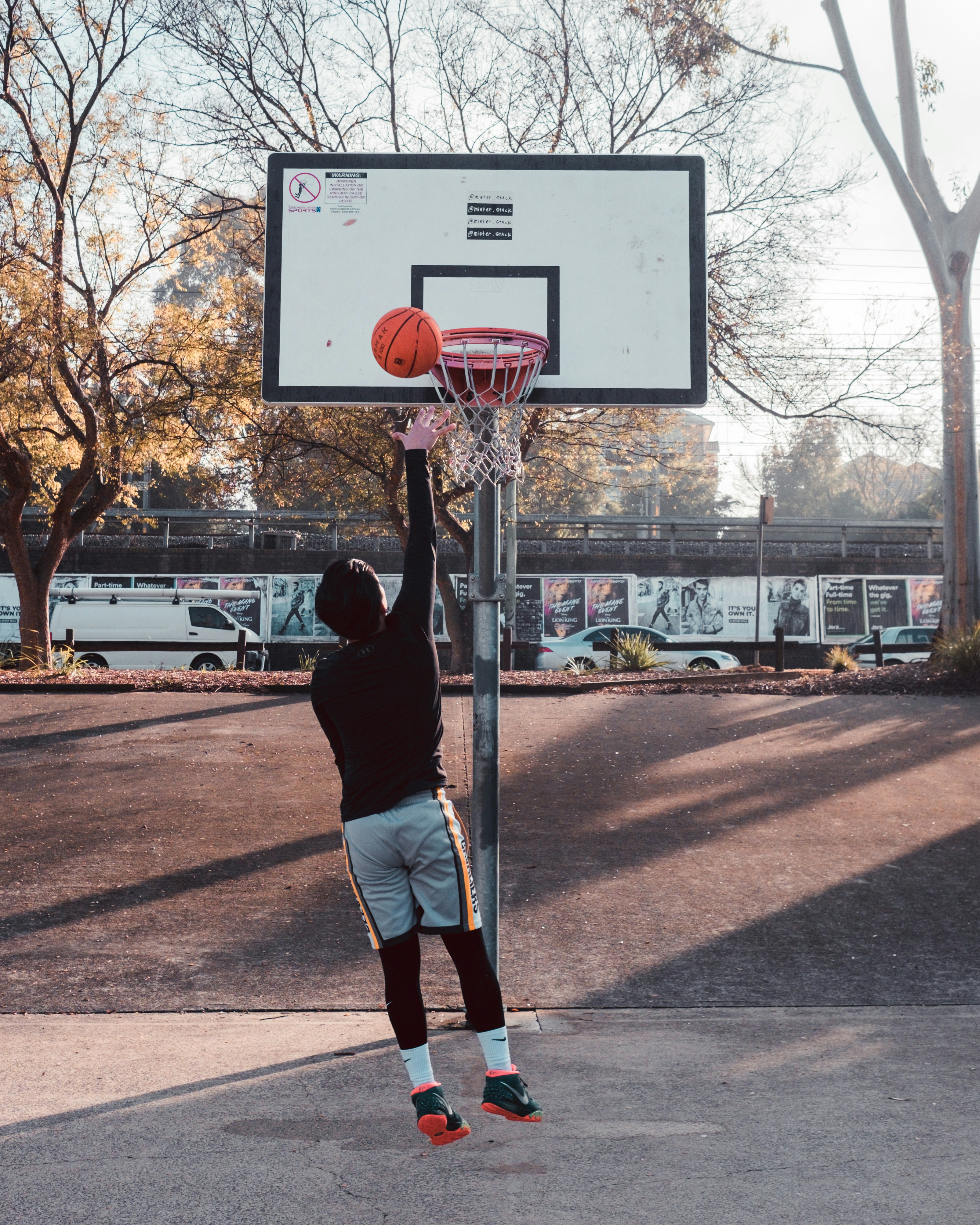 A man dunking a basketball into a basketball hoop photo – Free Sports ...