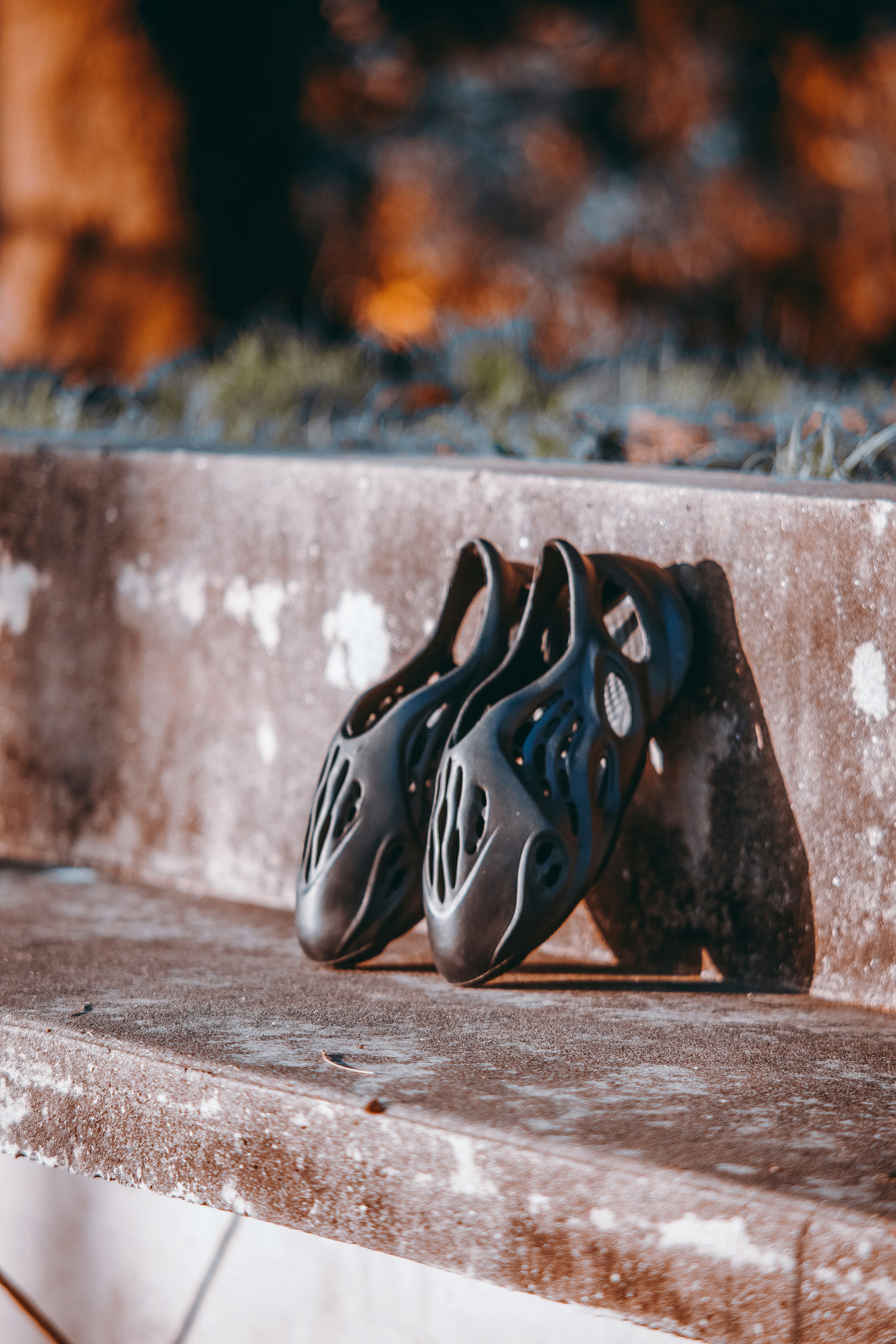 Autumn's Quiet Pause: Slip-On Sandals Rest on Weathered Concrete