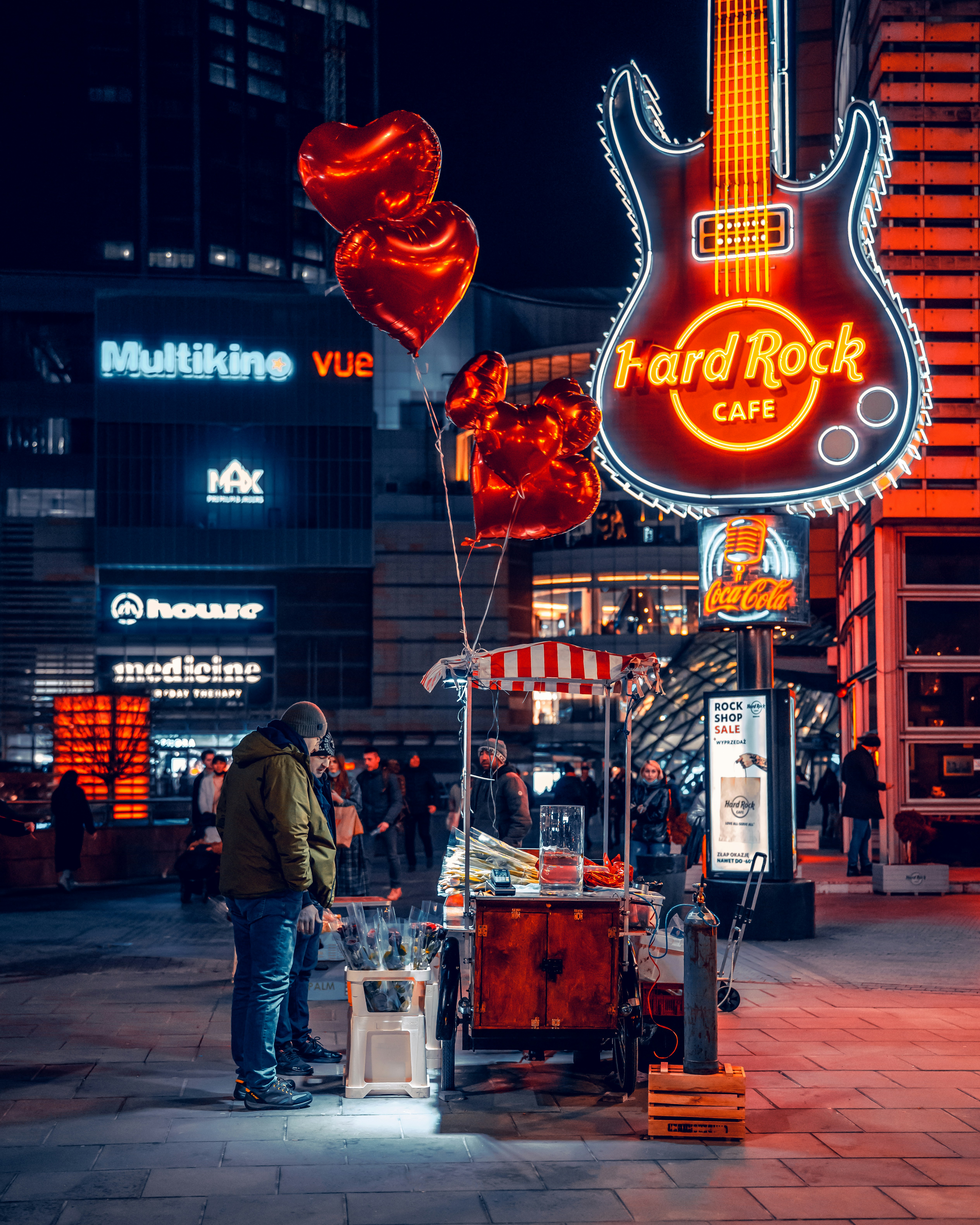 Neon Hard Rock Night: A Street Vendor in the Glow