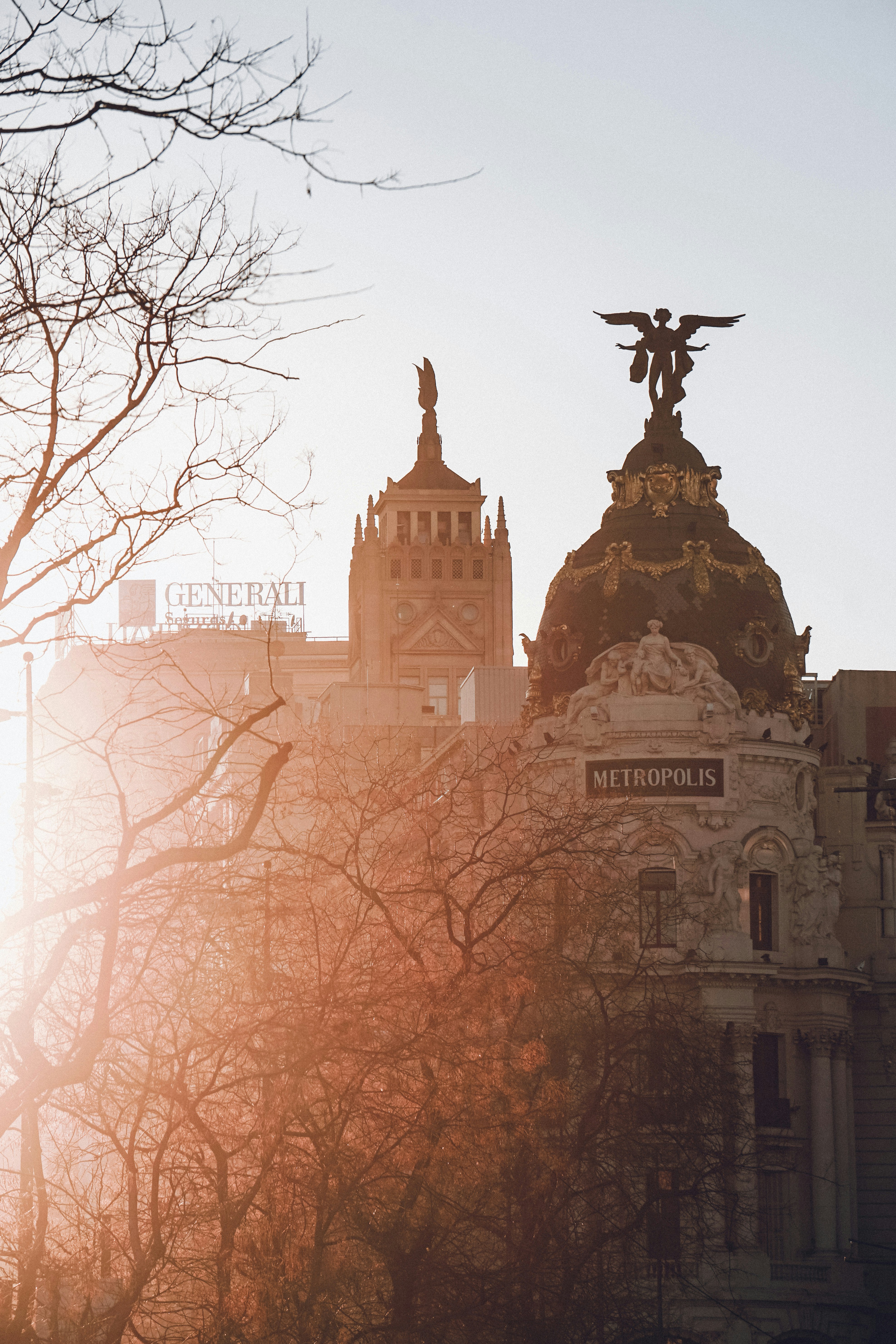 Dawn over Metropolis: Winged statue crowning Madrid's ornate dome