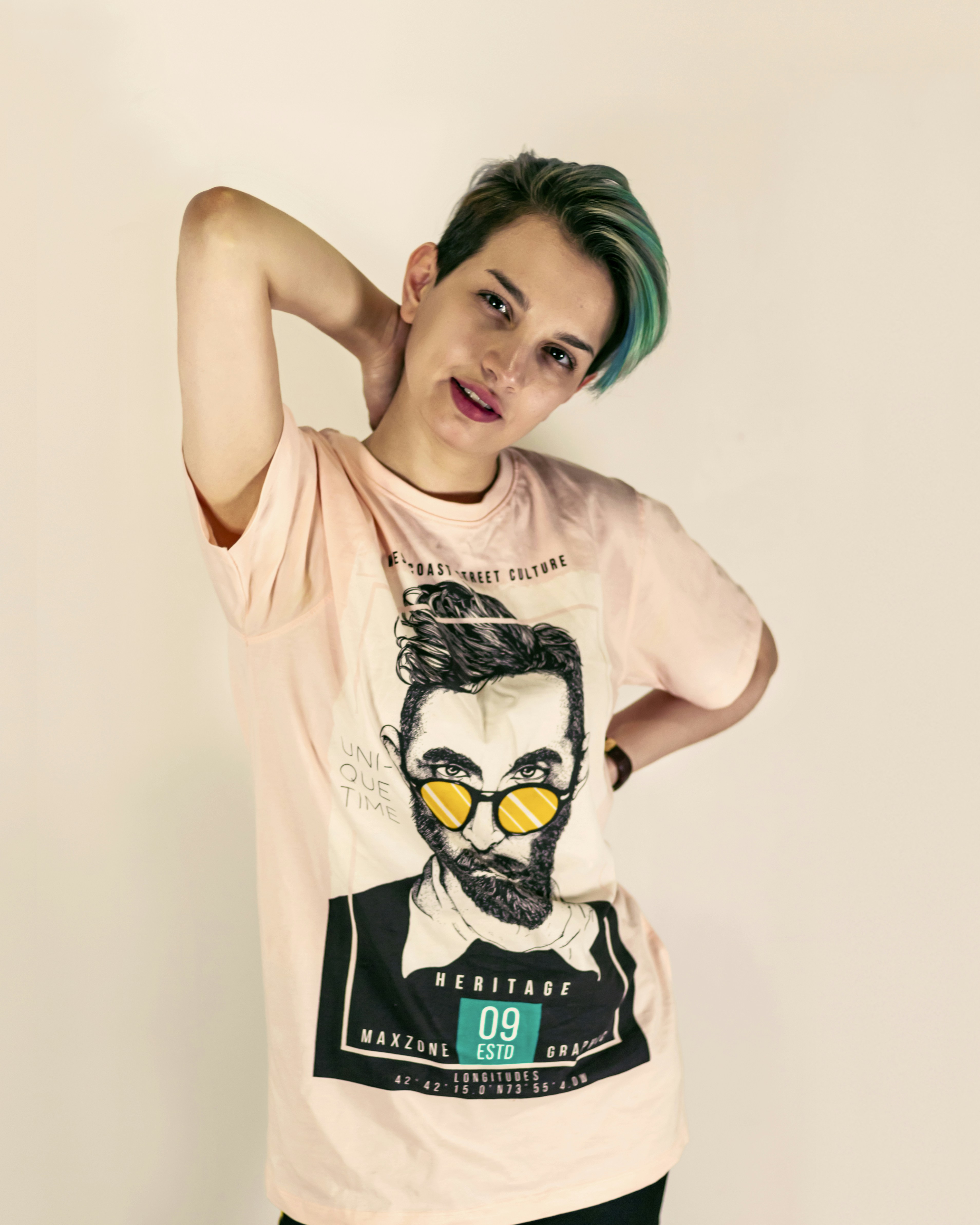 Teal-Streak Portrait: Studio Confidence in a Peach Tee