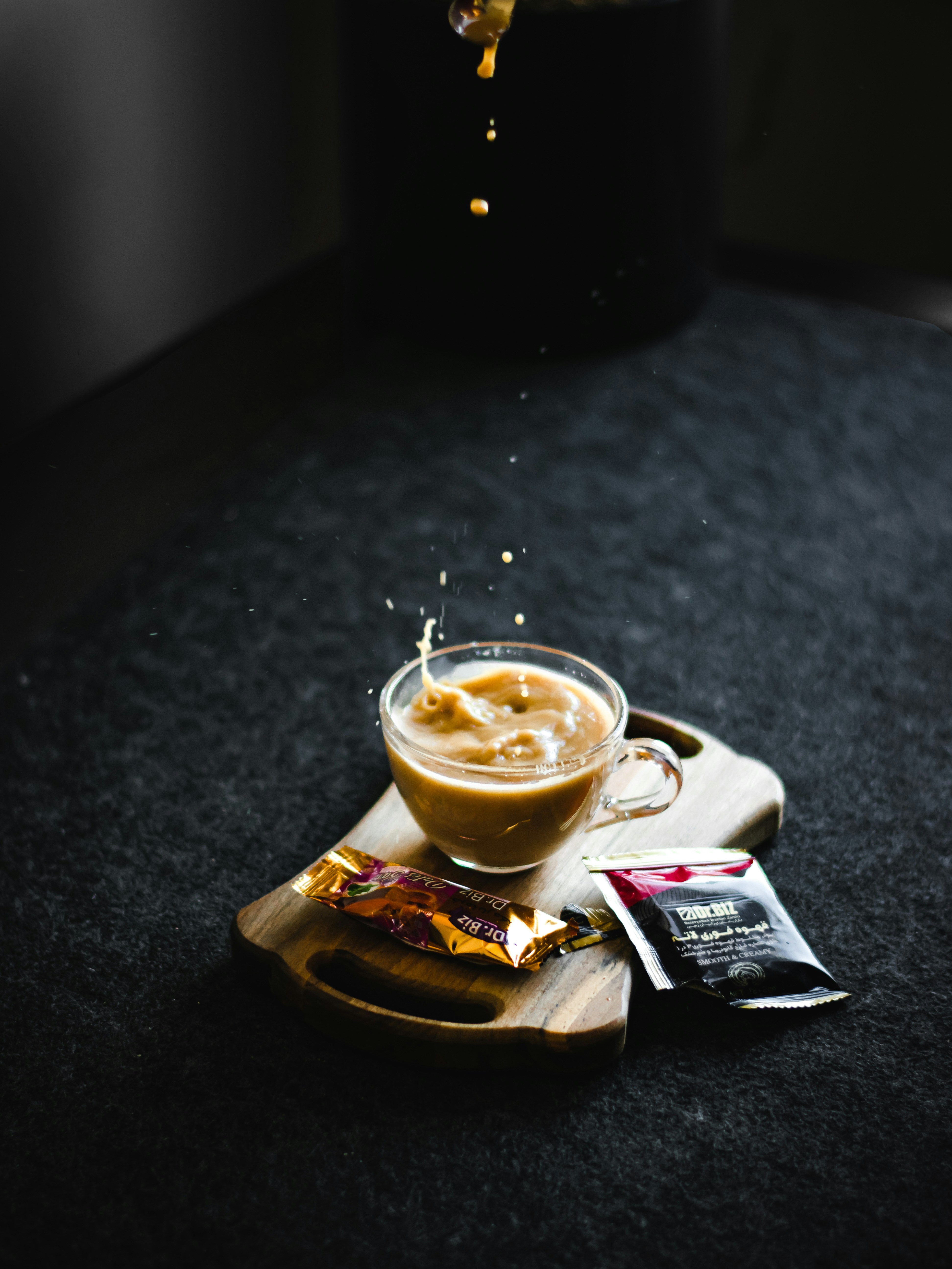 Cream Cascade Over Espresso: Droplets Freefall Onto a Wooden Tray