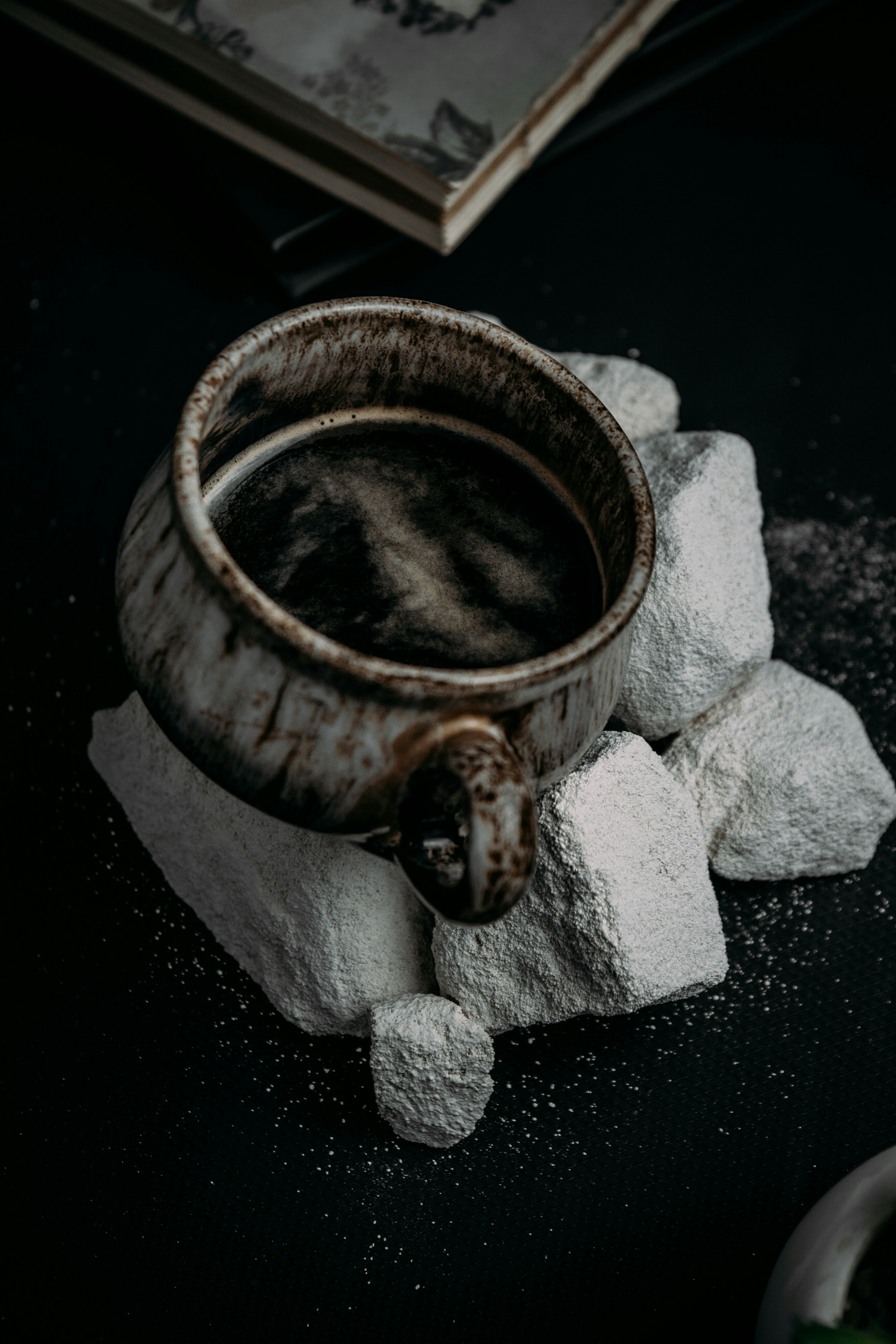 Moody Still-Life: A Rustic Mug Reposes on Chalky Prisms