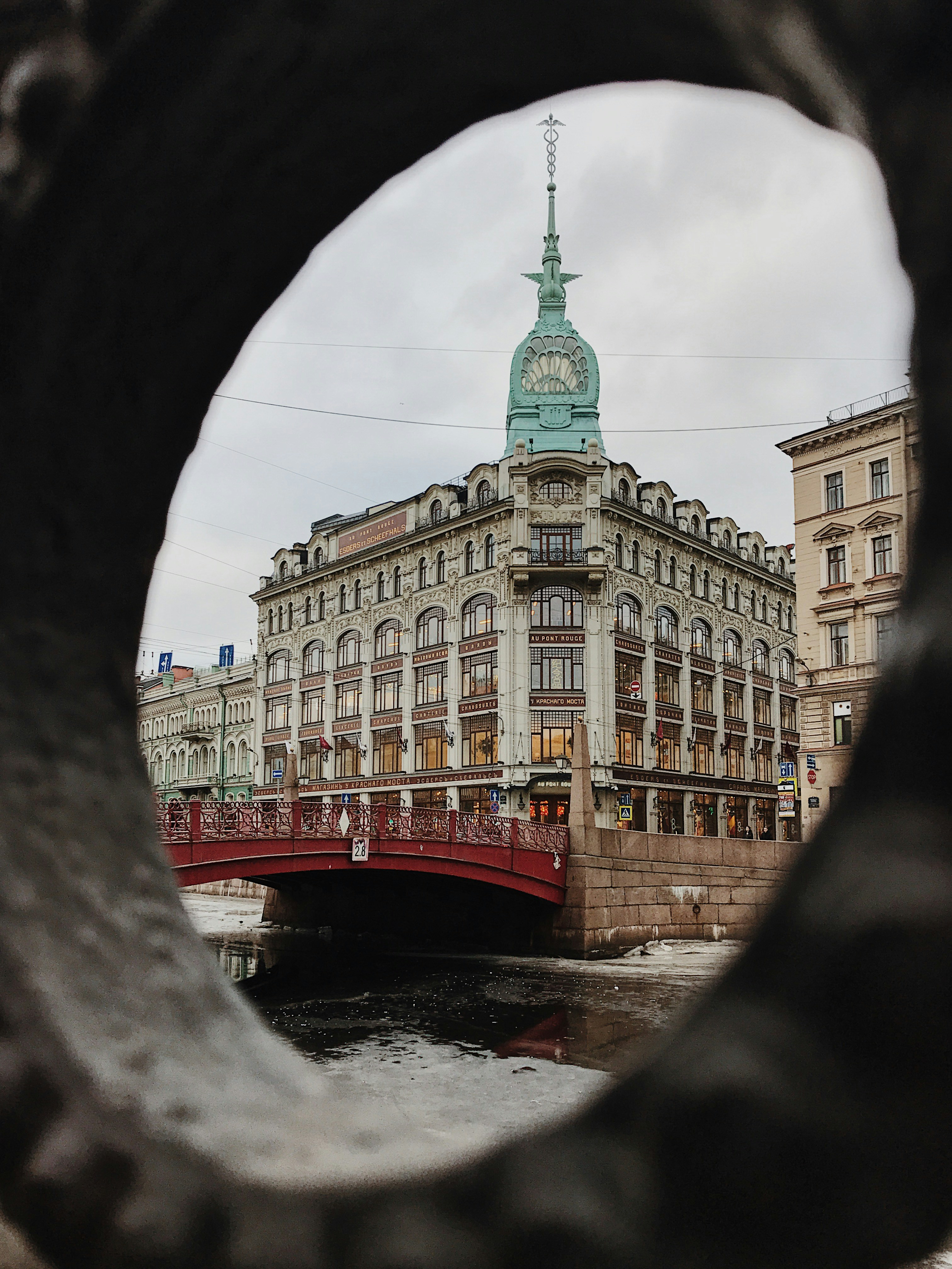 a view of a bridge over a river with a building in the background