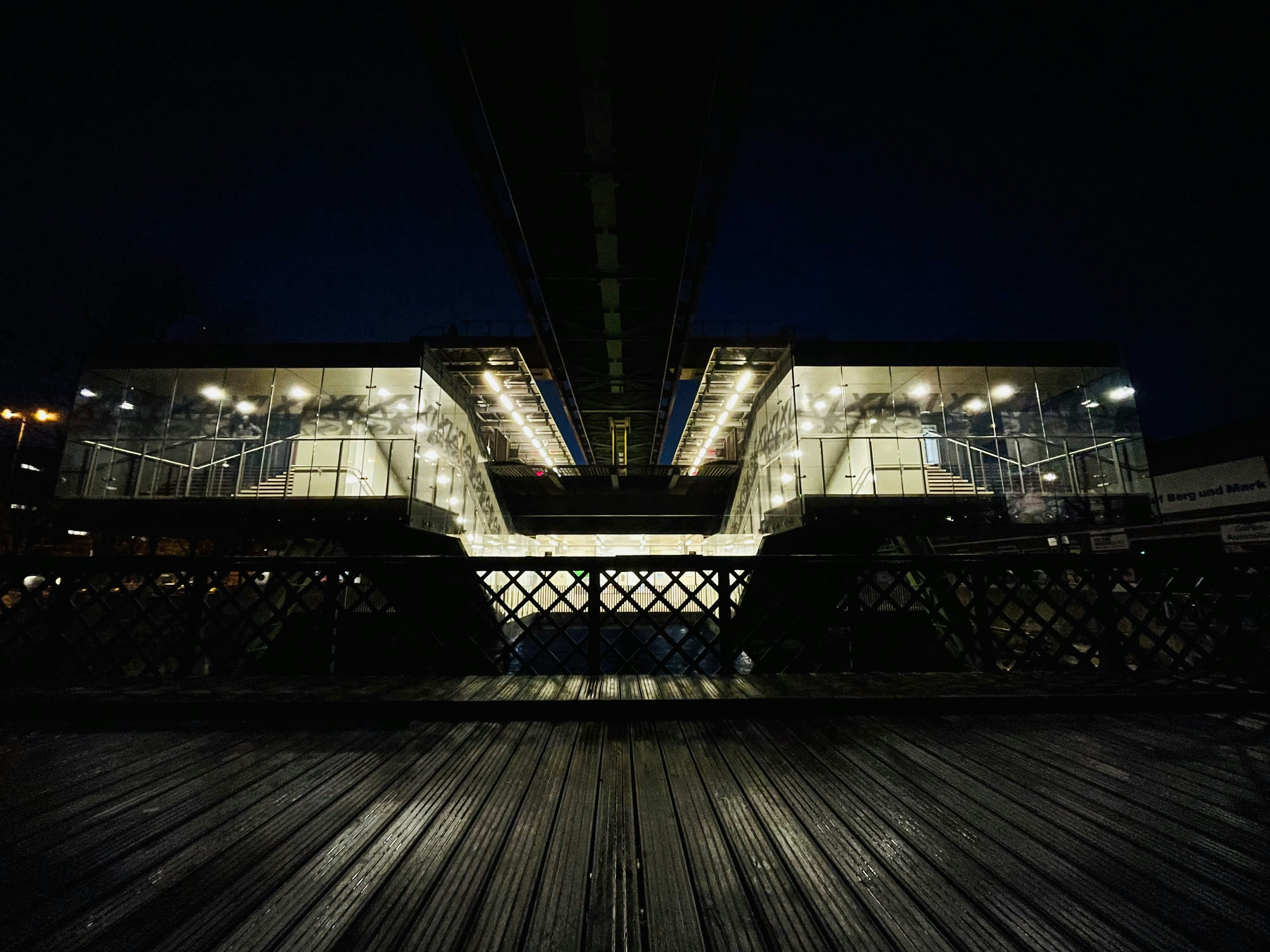 Midnight Crossing: Symmetry Beneath the Illuminated Glass Bridges