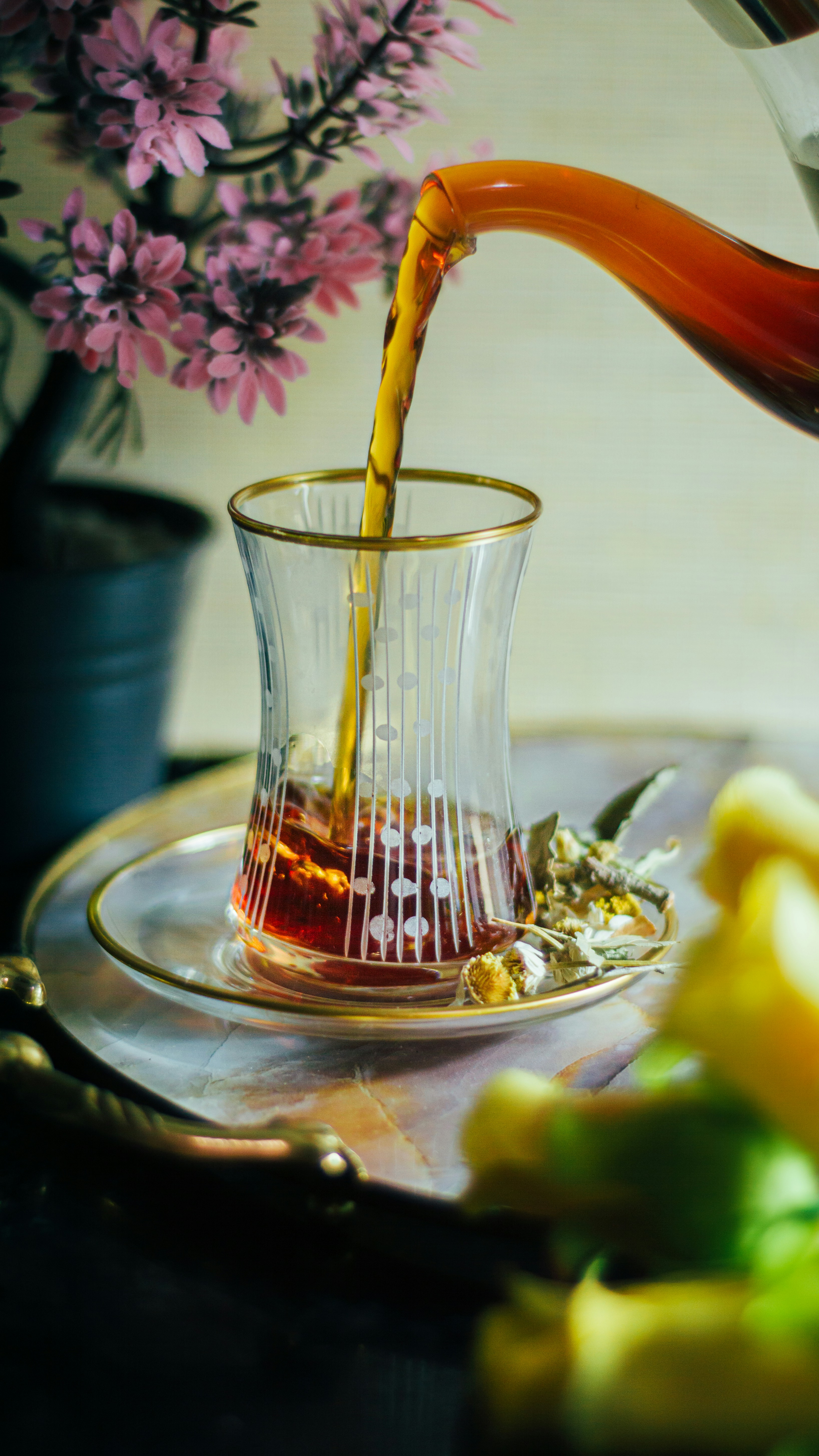 A pitcher pouring tea into a glass cup photo – Free Yellow Image on ...