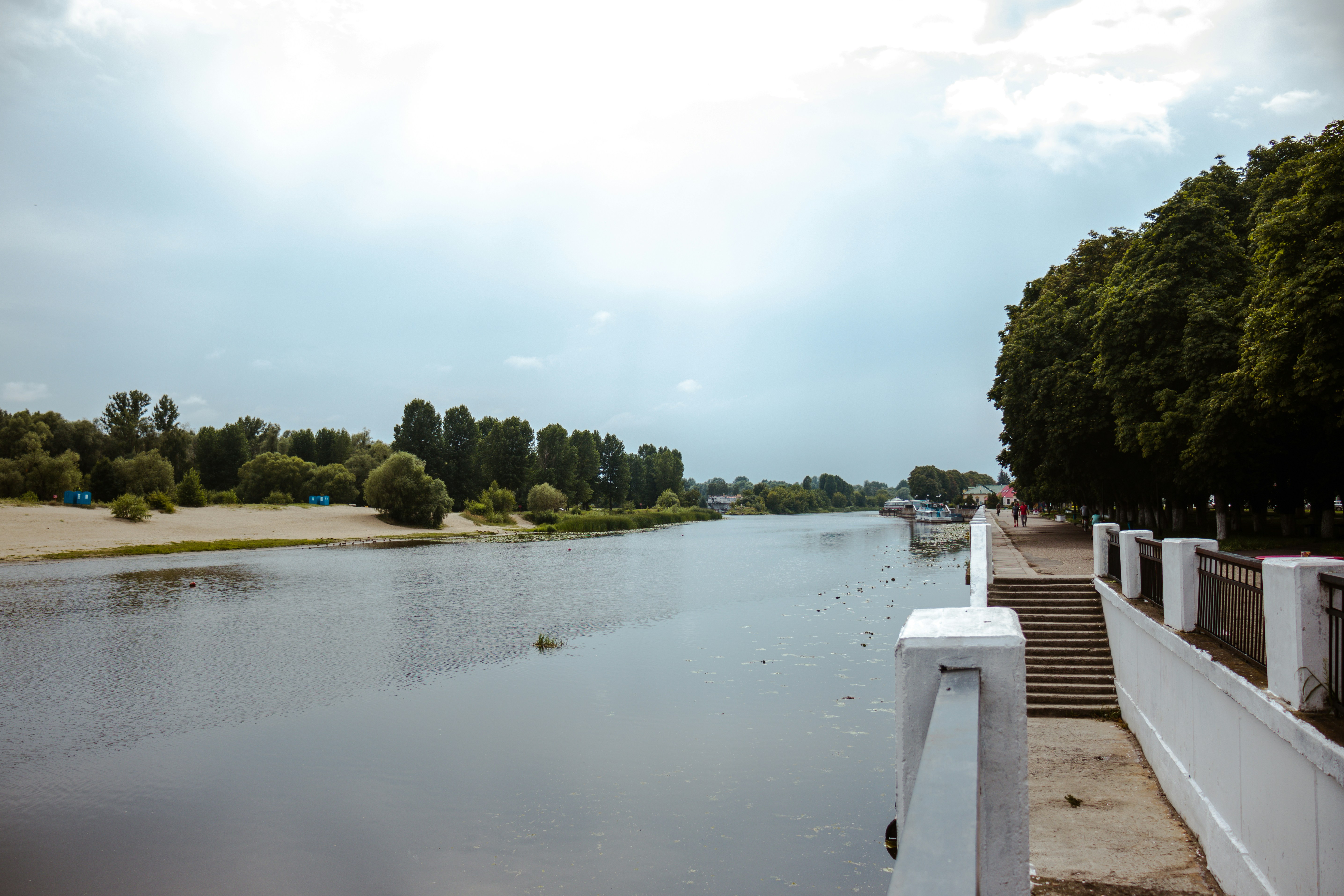 Riverside Veranda: White Railings Toward a Cloudy Horizon