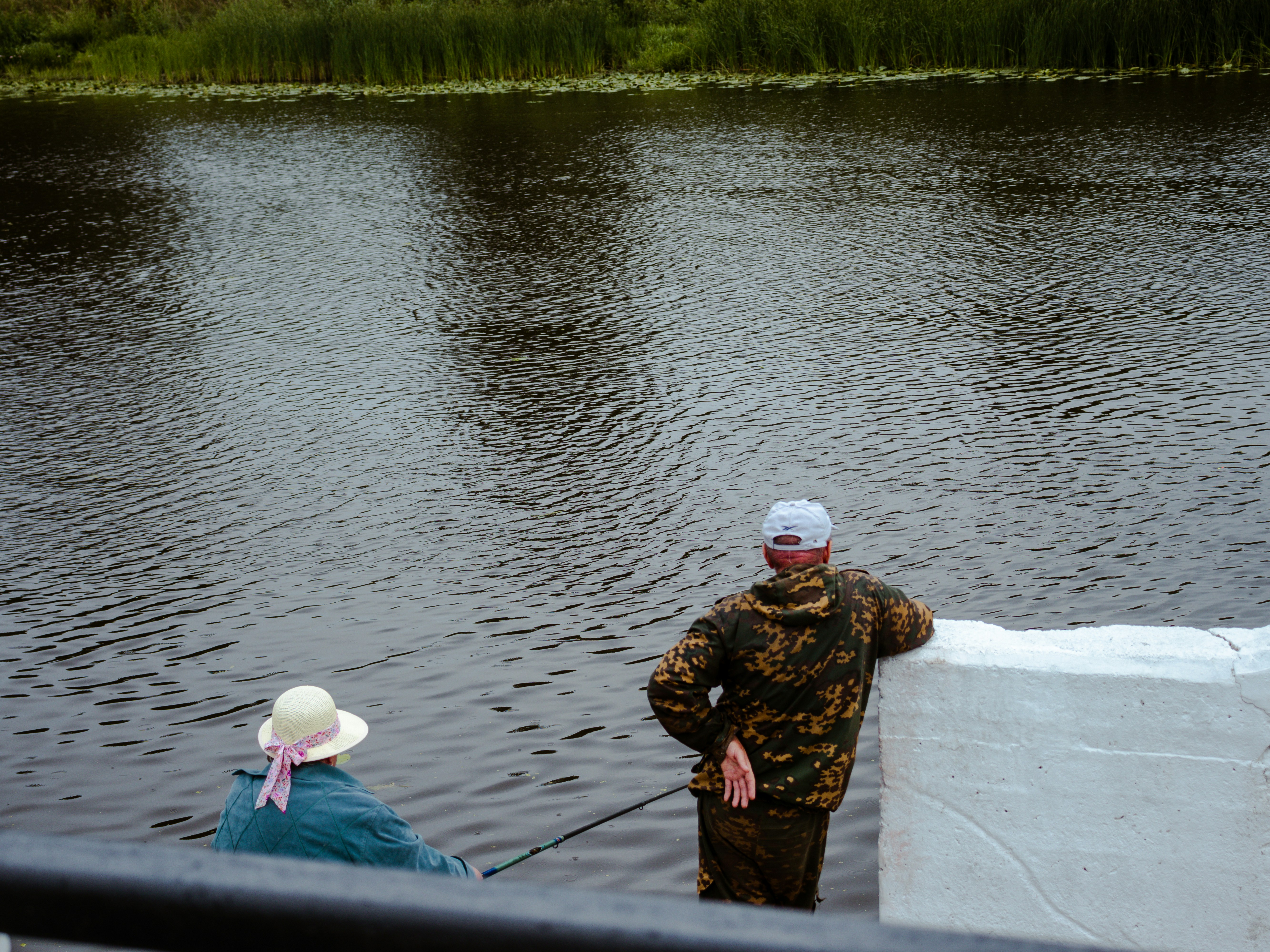 Camouflage Angler at the River's Edge