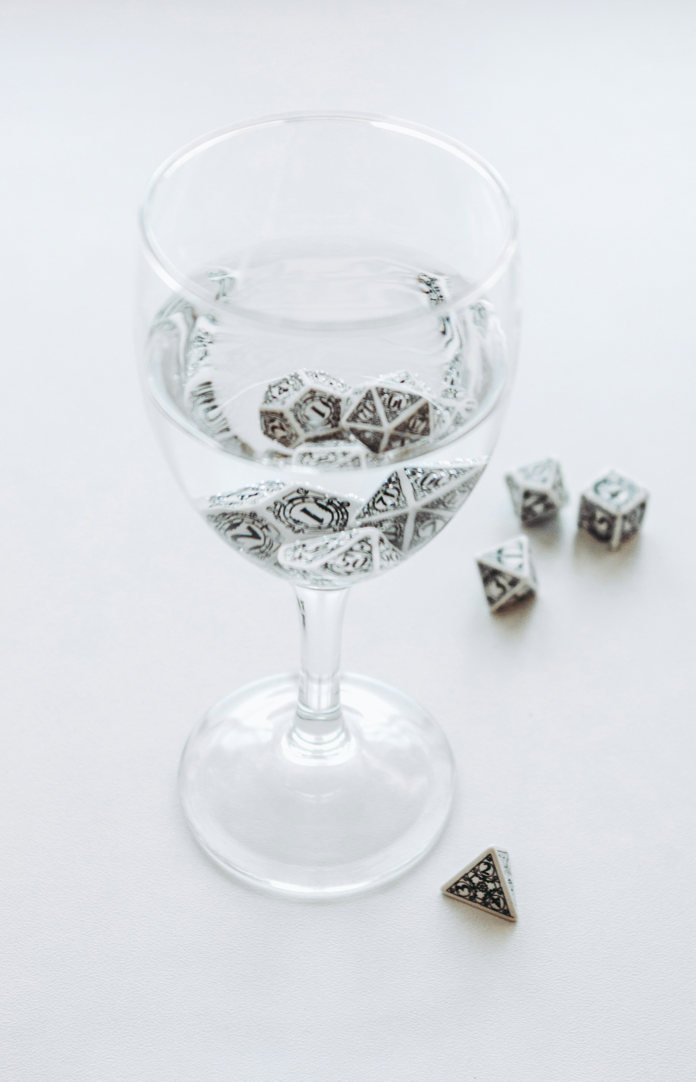 A glass of wine with dice on the side photo – Free Grey Image on Unsplash