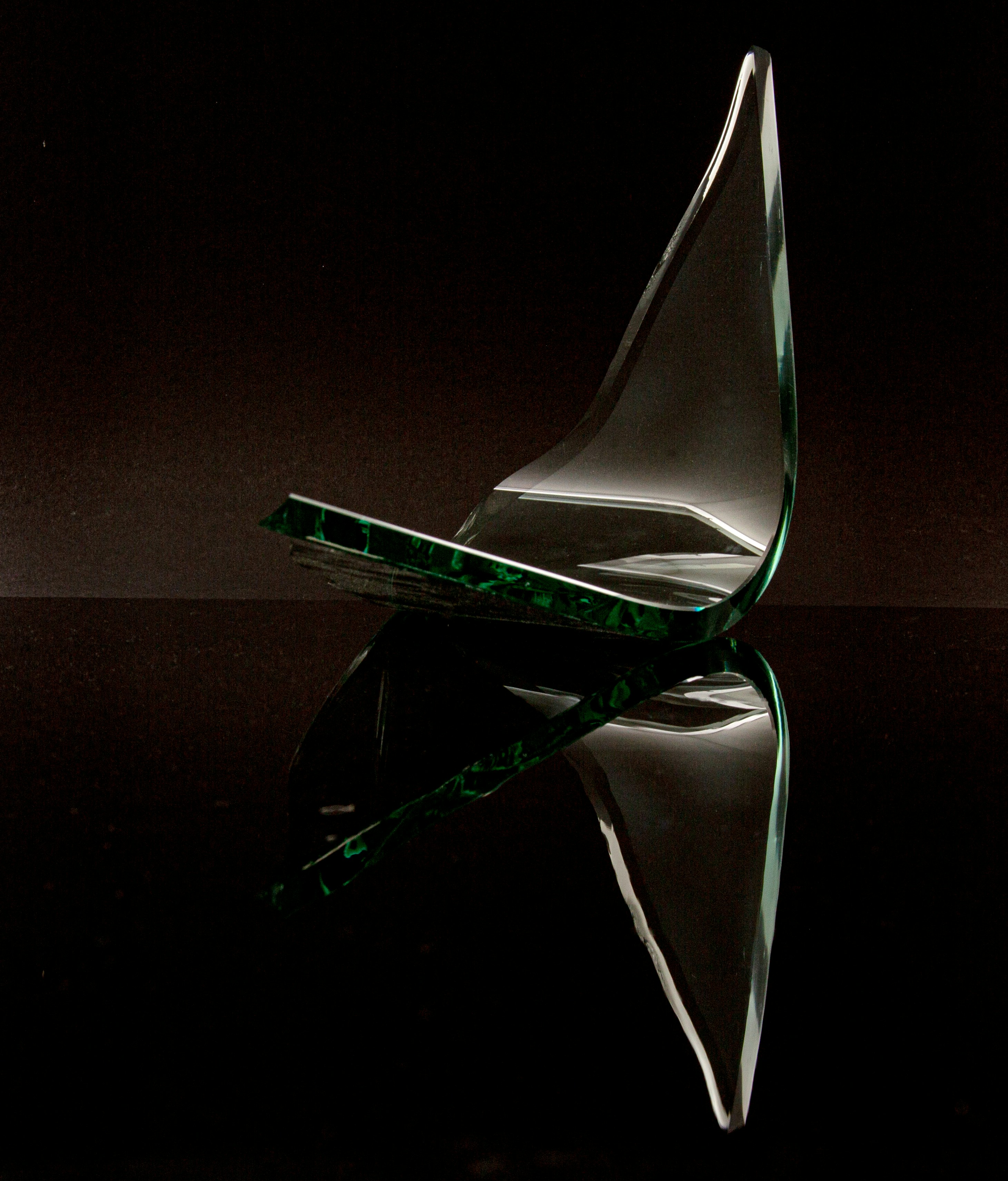 Emerald-edged Glass Crescent Balancing on a Mirror