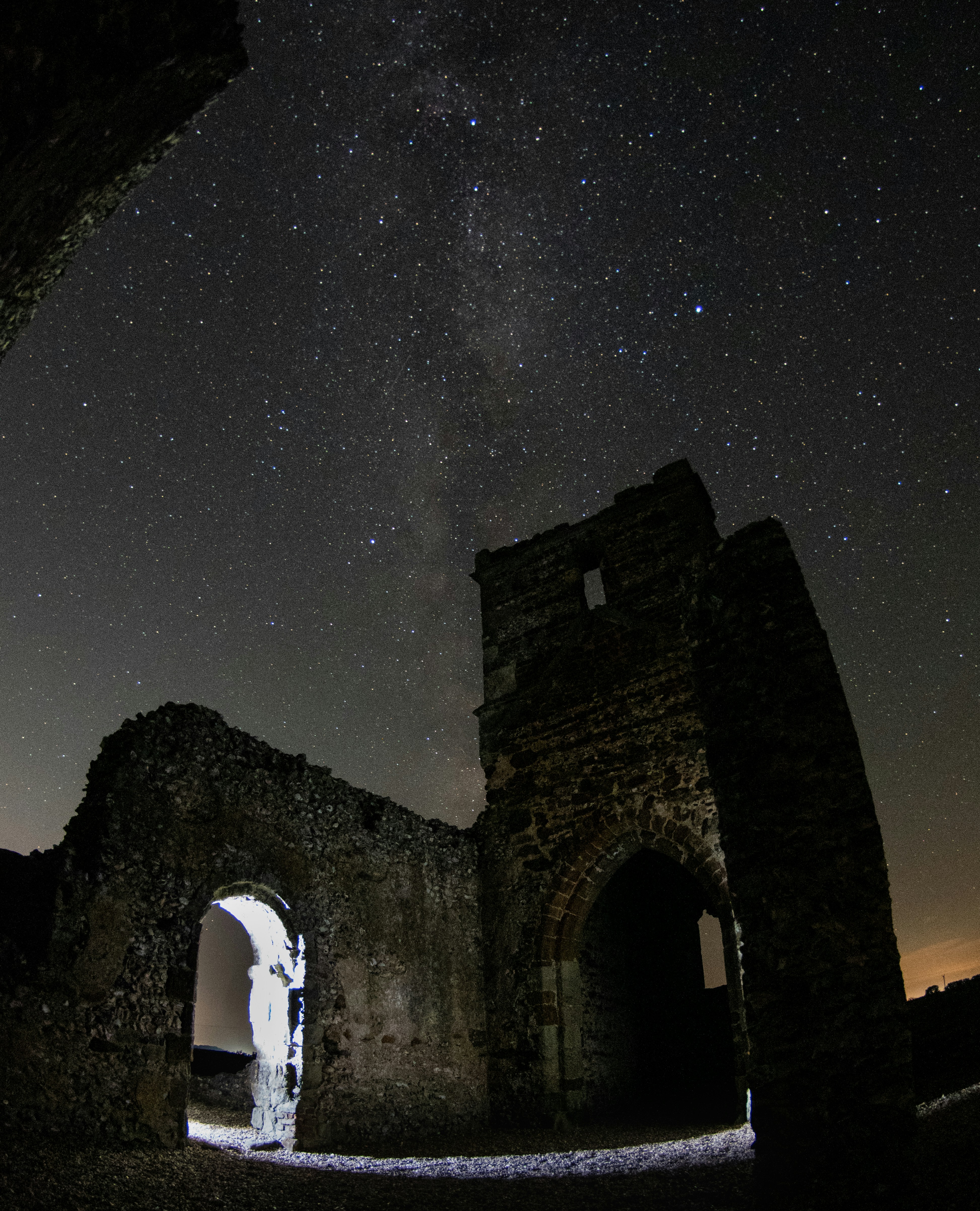 Une personne debout dans l’embrasure d’une porte sous un ciel nocturne ...