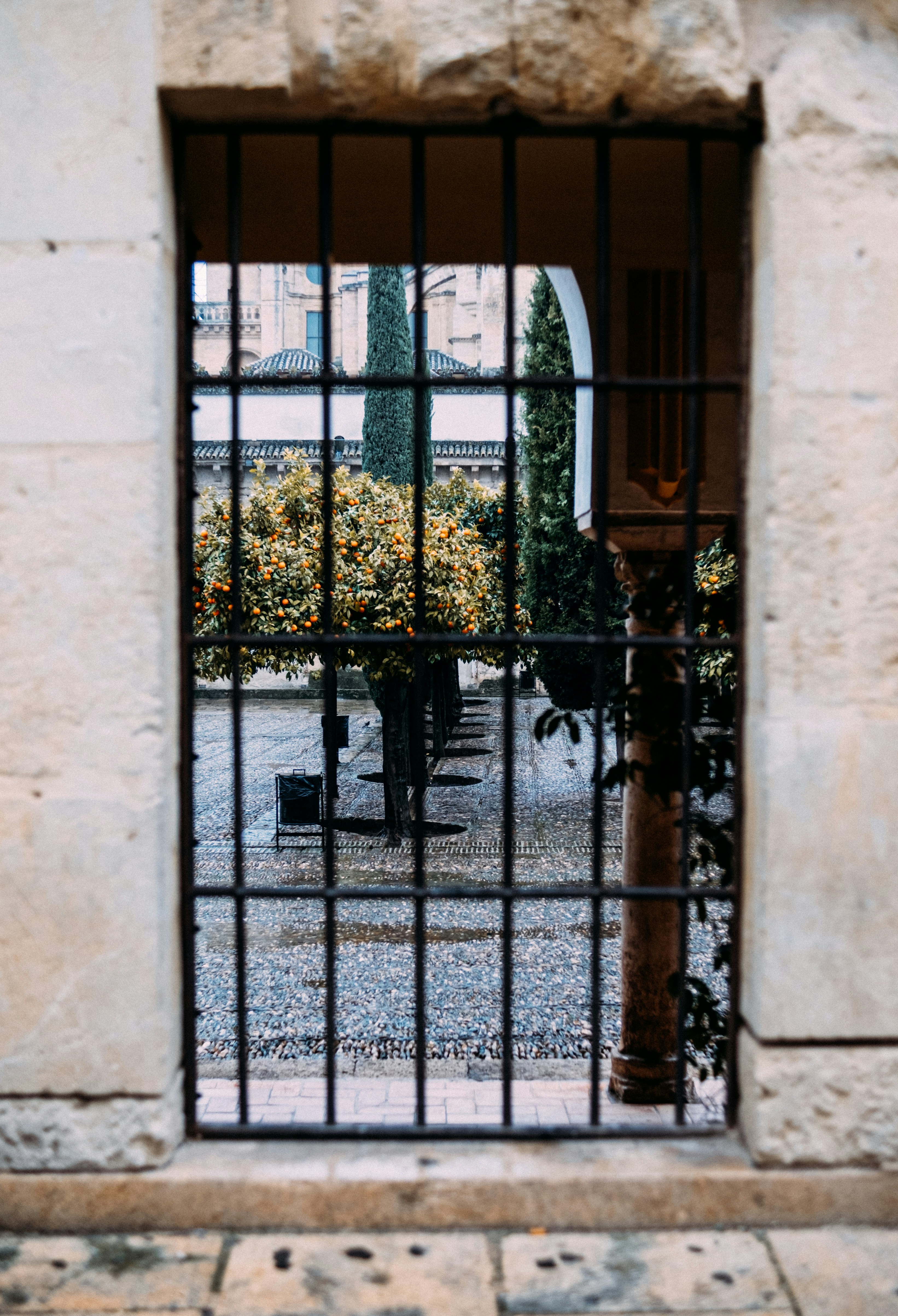 A view of a courtyard through a barred window photo – Free Córdoba ...