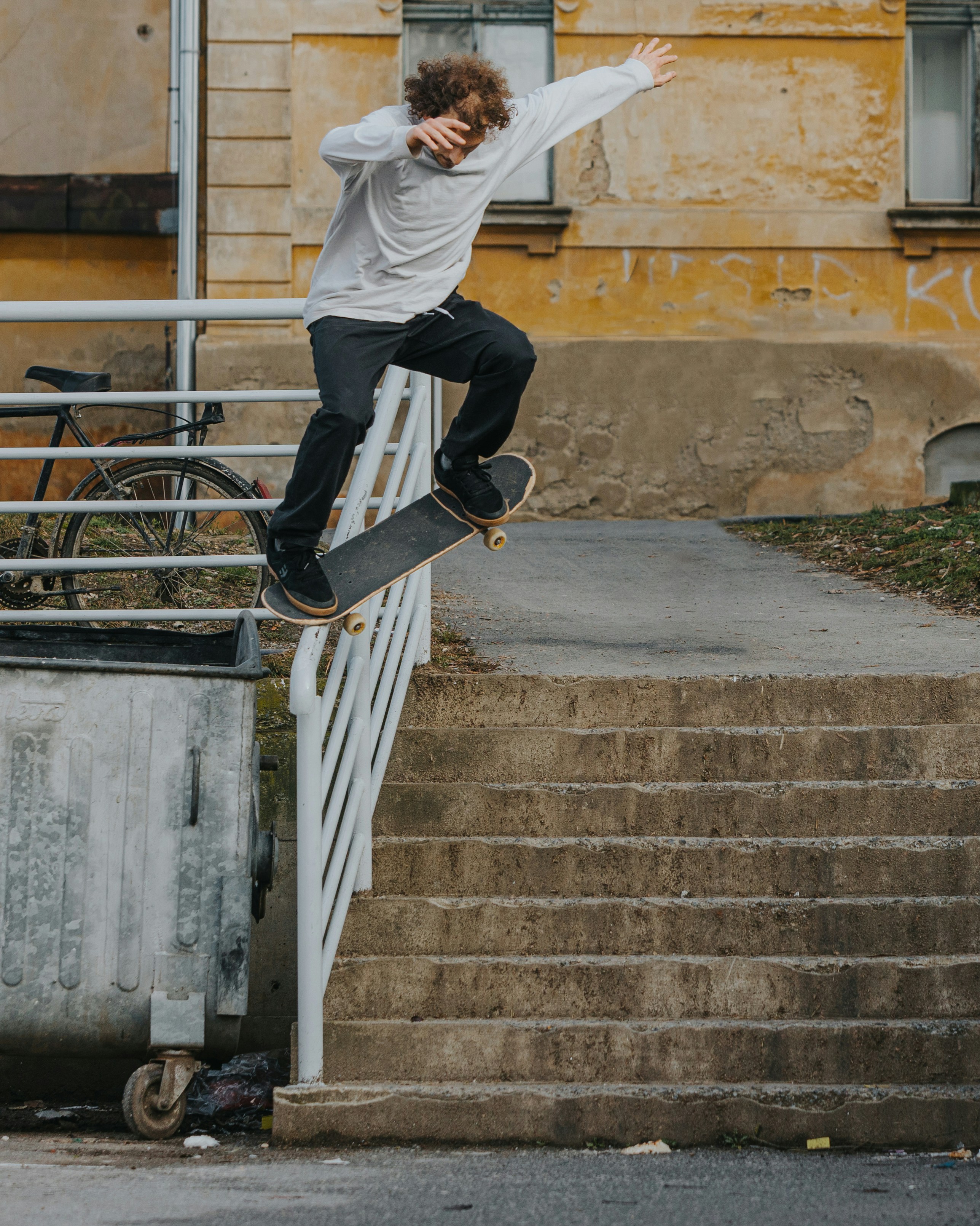 A man riding a skateboard up the side of a set of stairs photo – Free ...