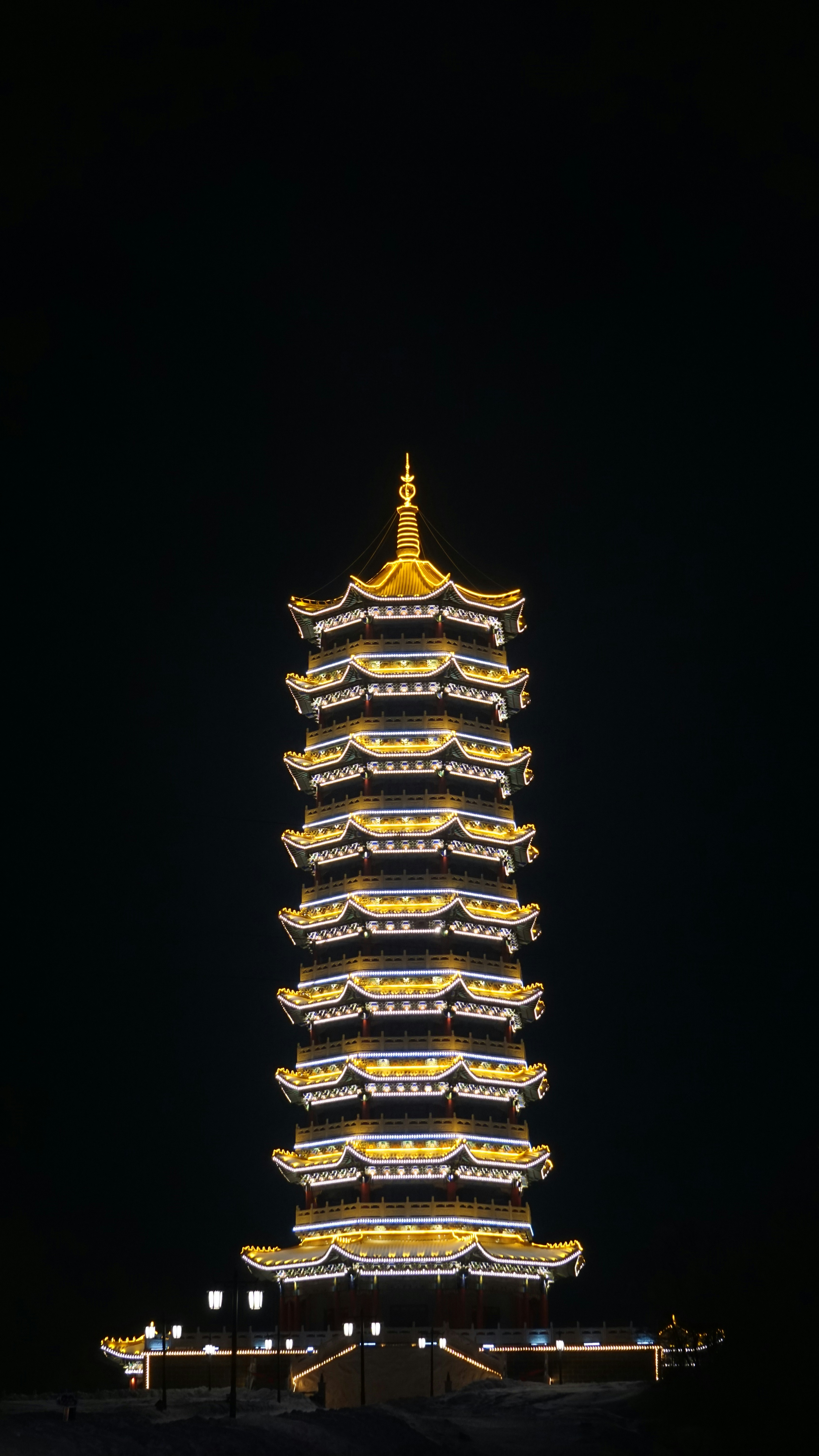 a tall tower lit up at night with lights