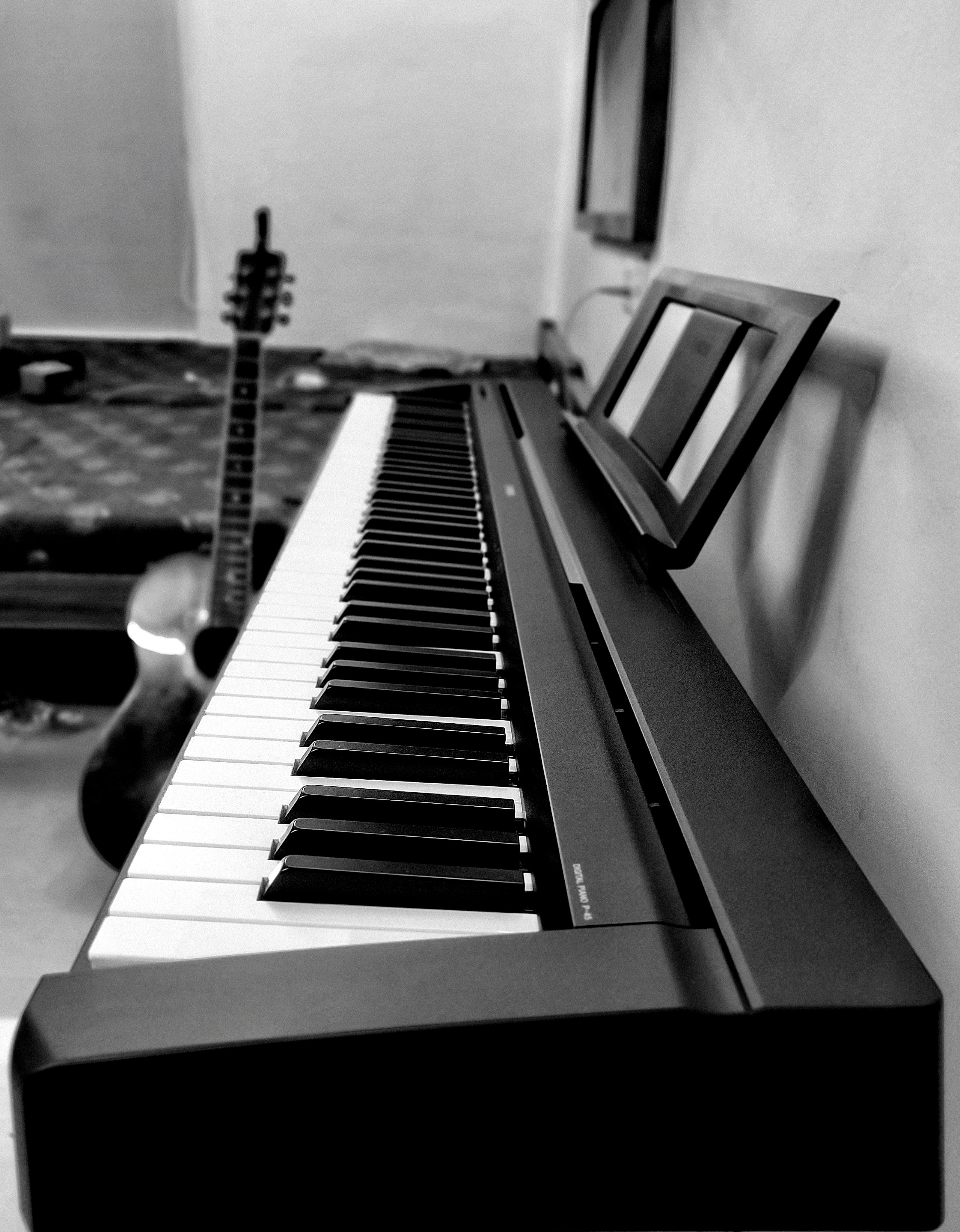 Noir Keys, Quiet Guitar: A Diagonal Studio Portrait