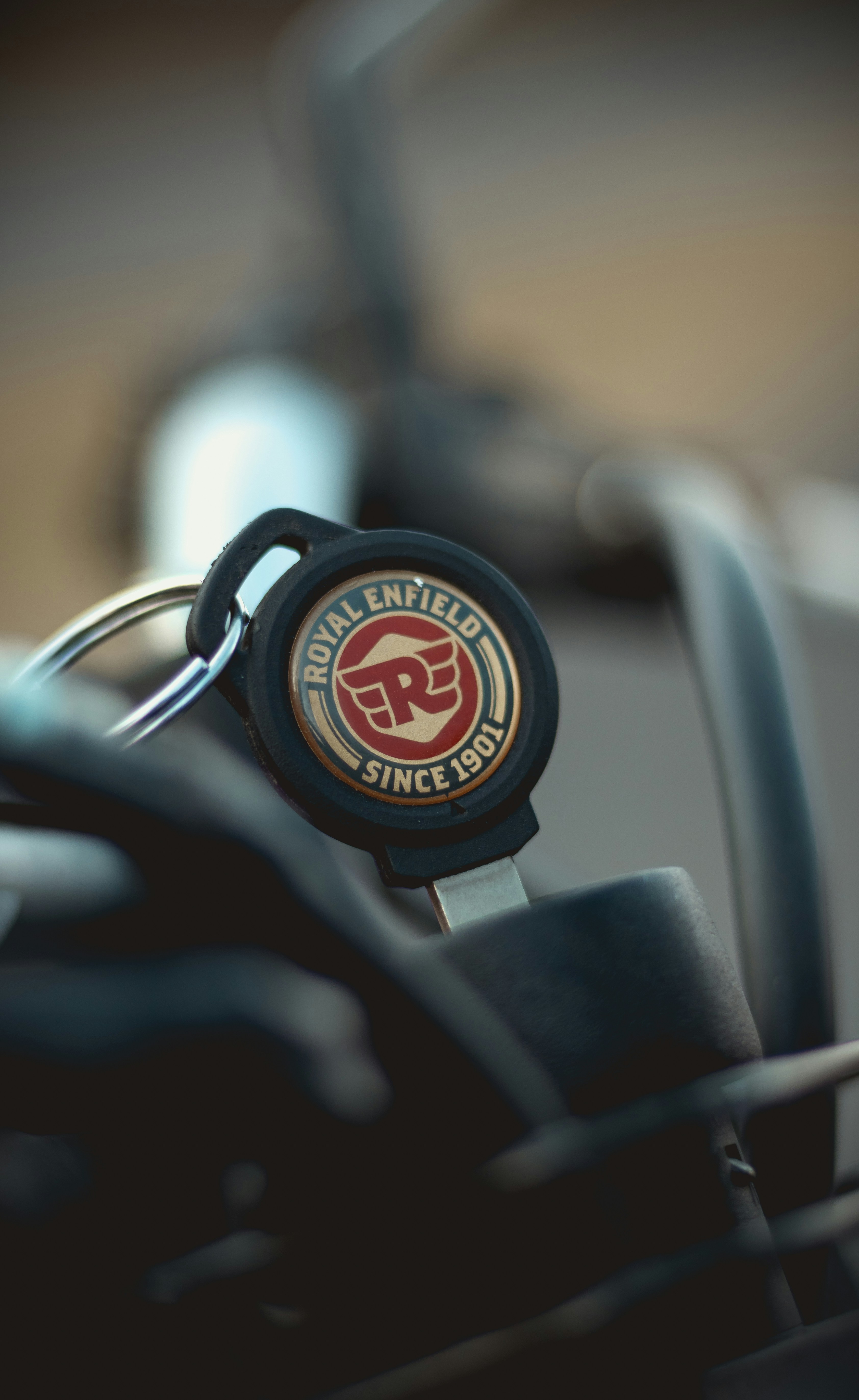 Royal Enfield Key: A Close-Up on the Emblem with Mechanical Depth