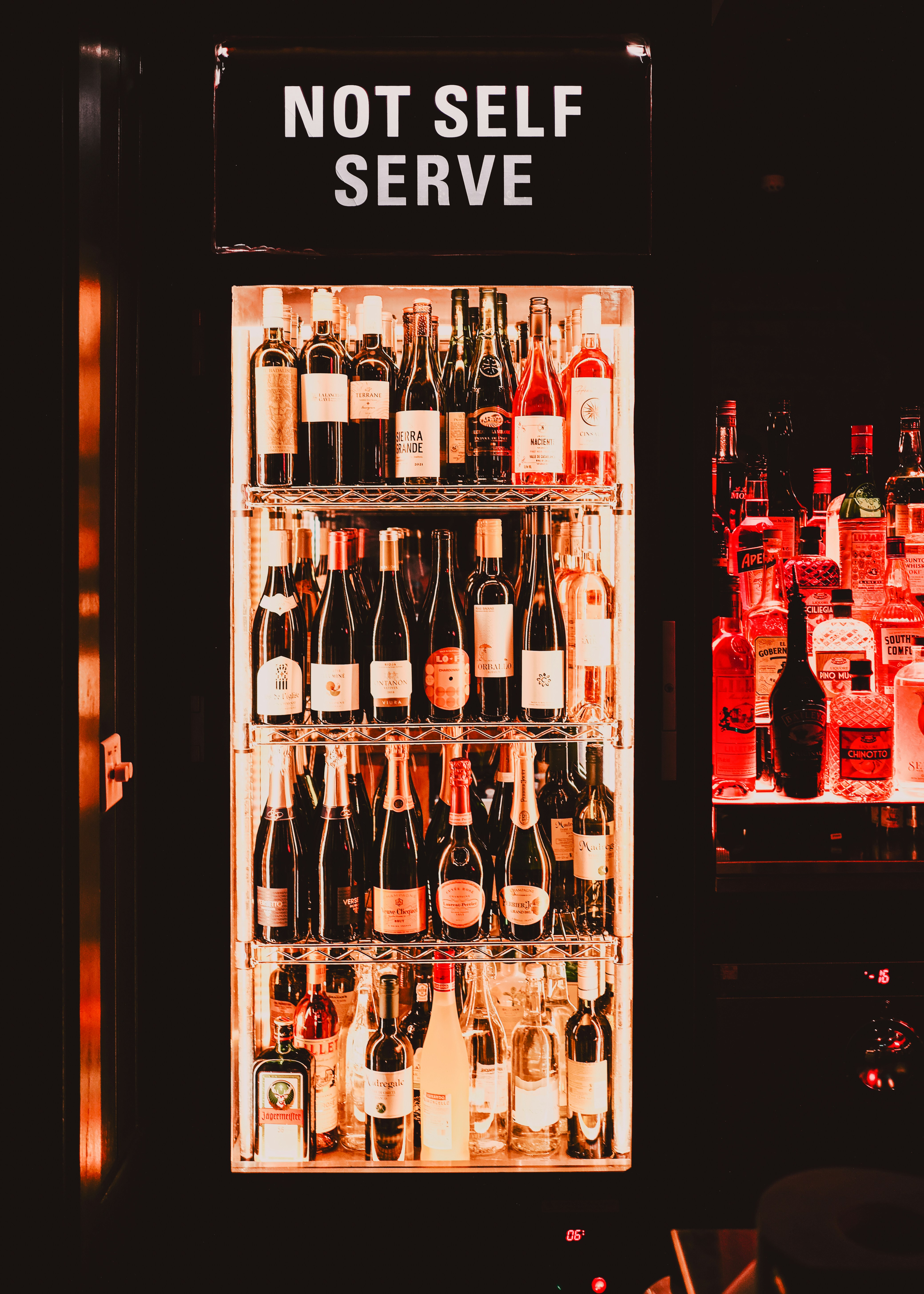 Not for Self-Serve: Bottled Collection Glistens in a Neon Fridge