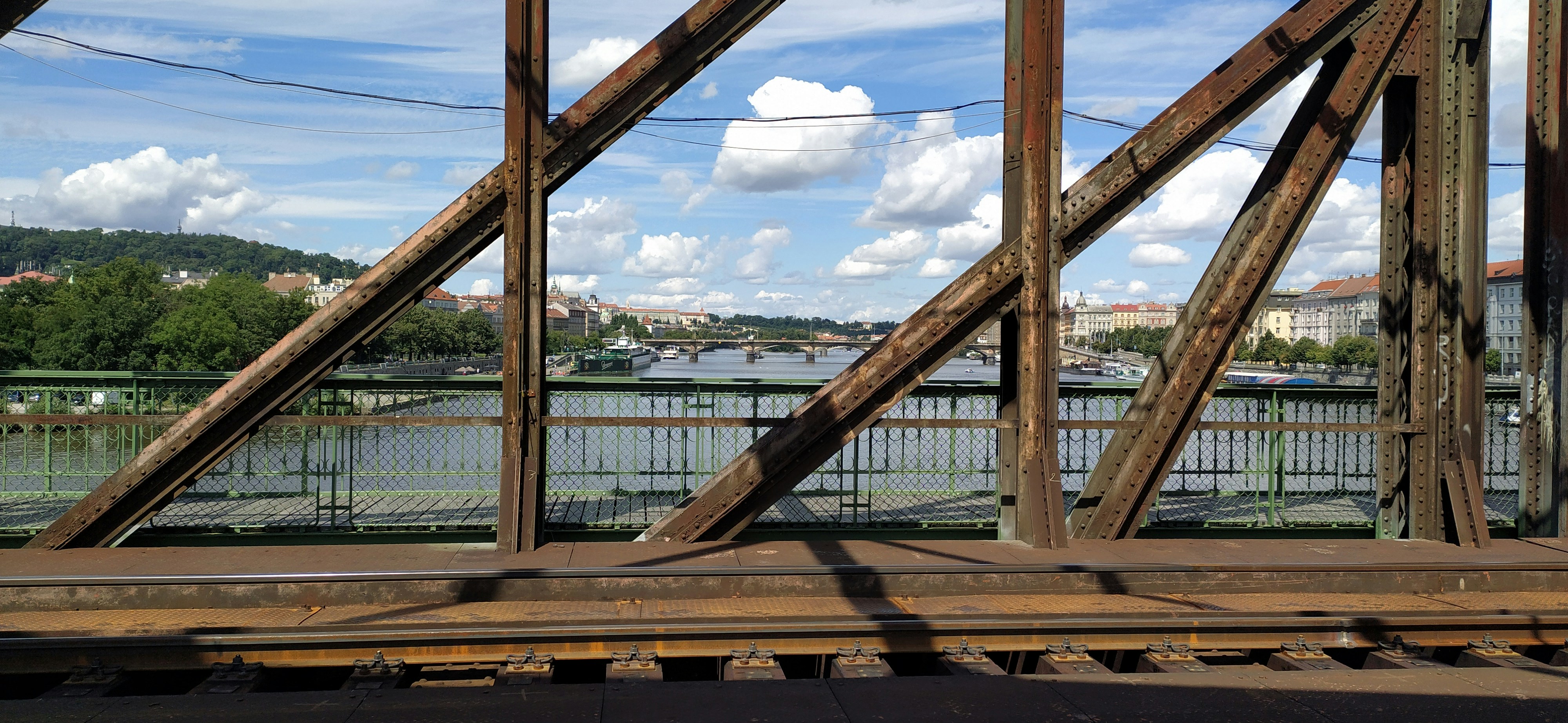 Crisscrossed Ironwork Framing a Tranquil River