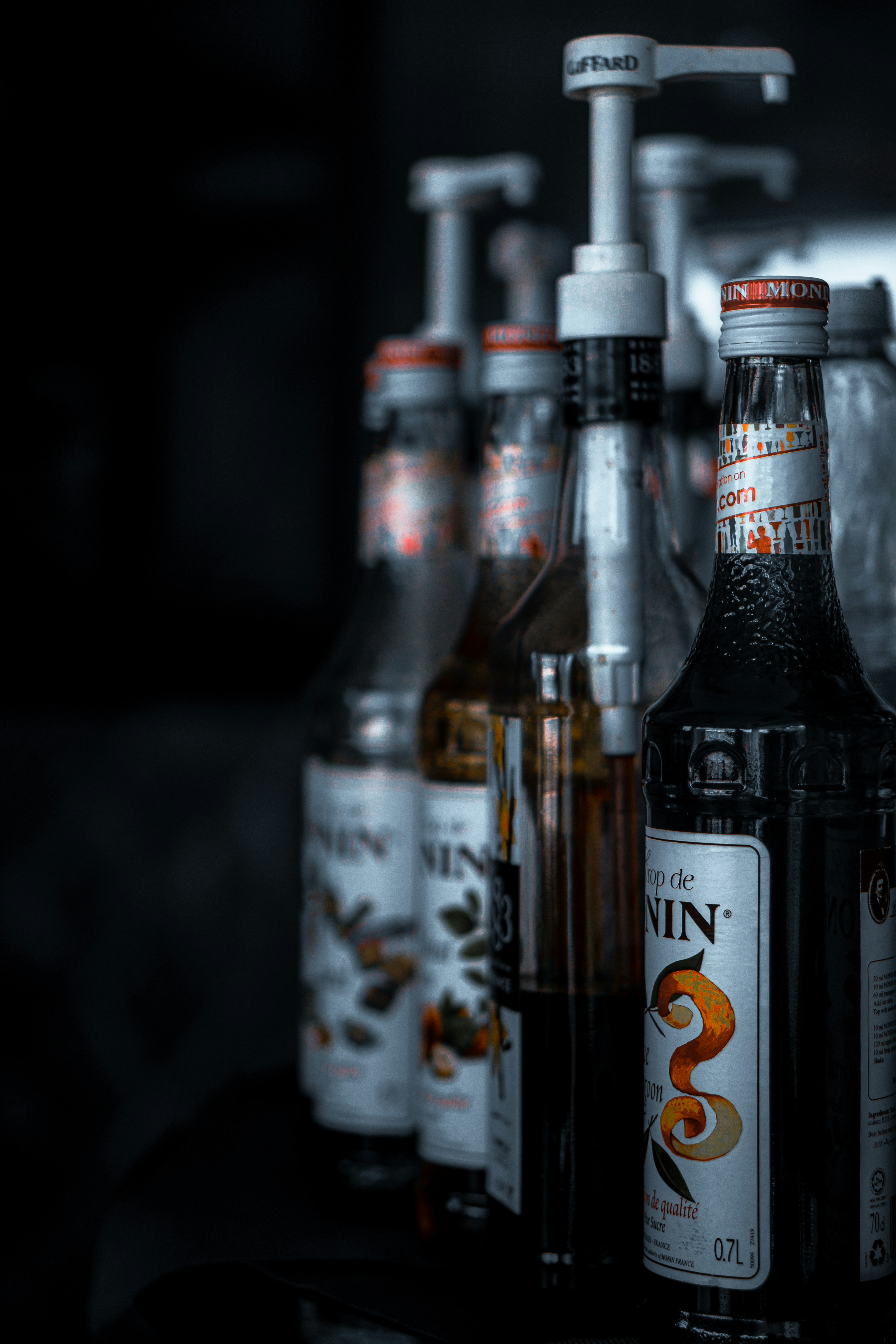 Amber Shadows: A Row of Bar Bottles in Focus