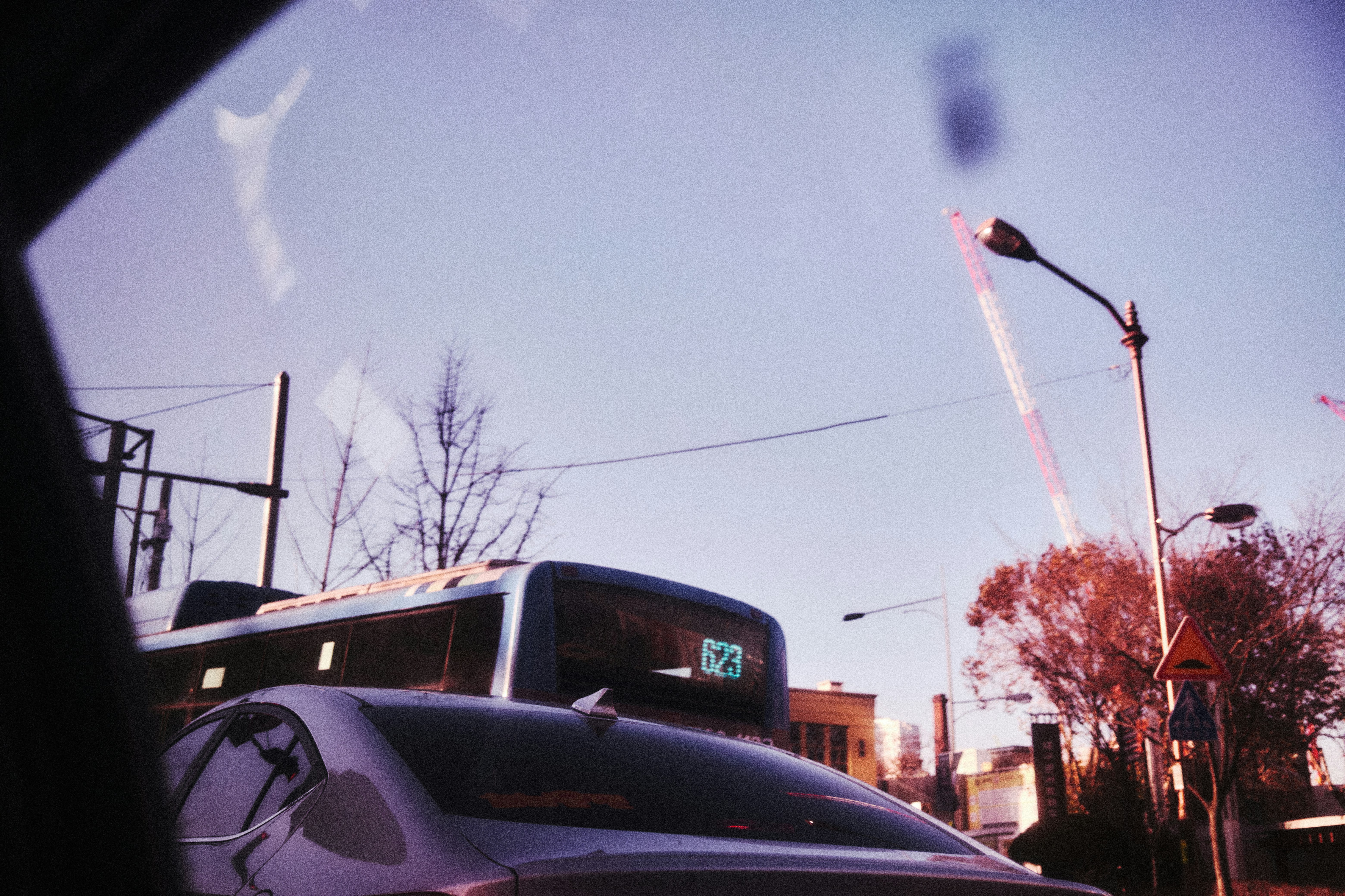 Framed in Transition: A City Street Under Construction Through a Car Window